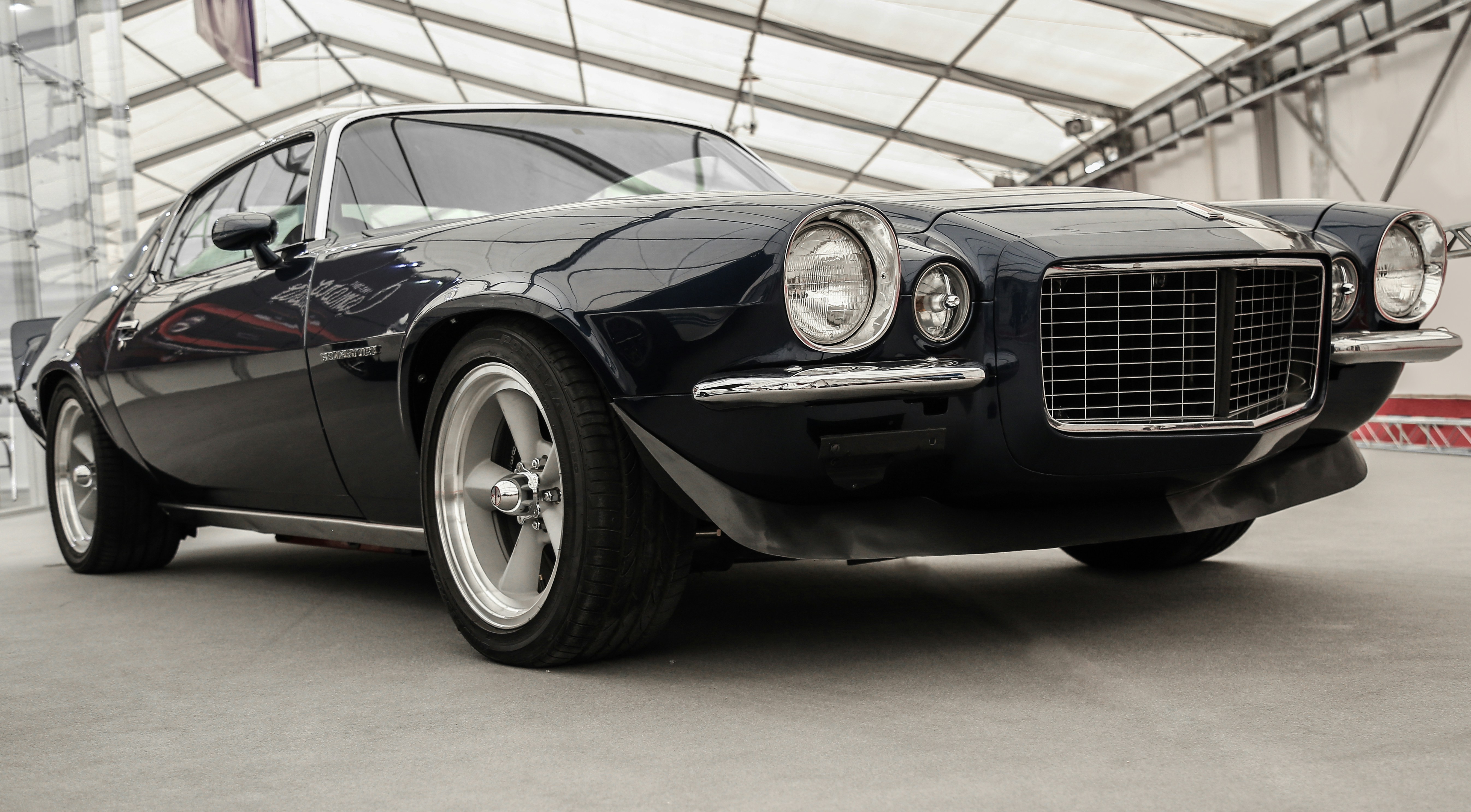 A 1973 Chevrolet Camaro — the perfect blend of muscle, style, and attitude. A timeless American icon that still turns heads. 🔥🇺🇸 | A dark blue vintage car with silver wheels