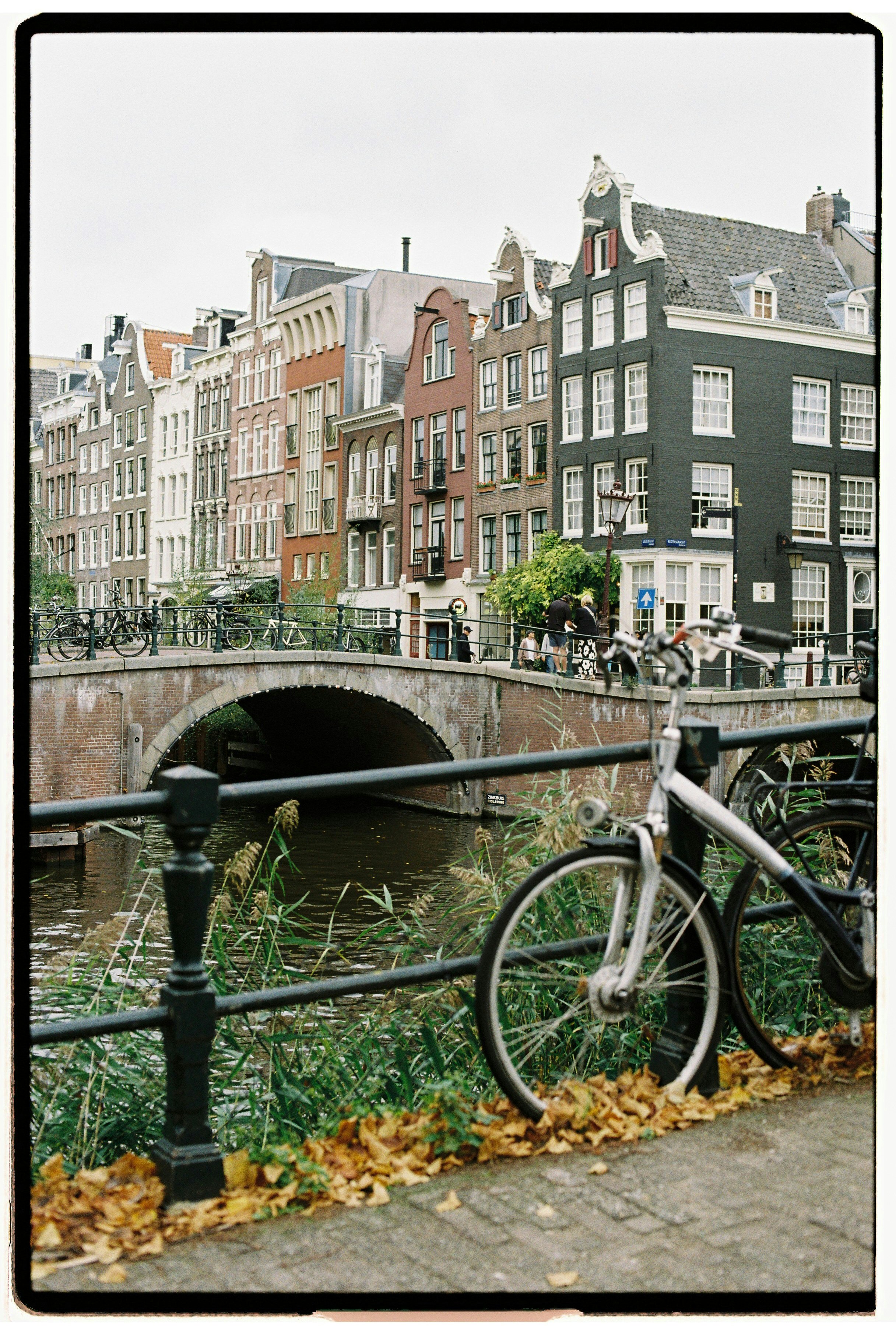 Canal and historic buildings with bicycles in amsterdam.