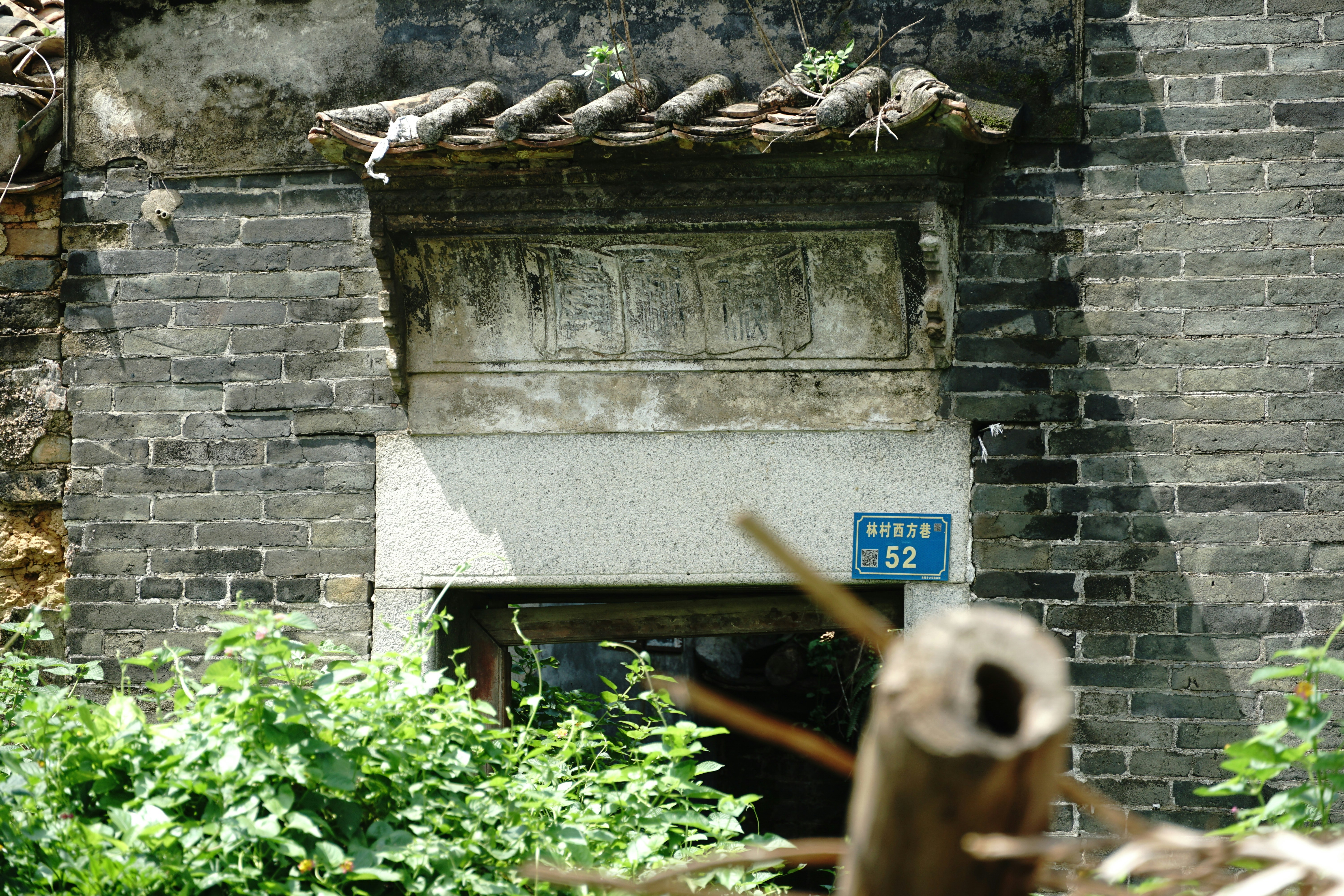 Threshold of Time: Mossy Brick Doorway Beneath Watchful Roof Lizards
