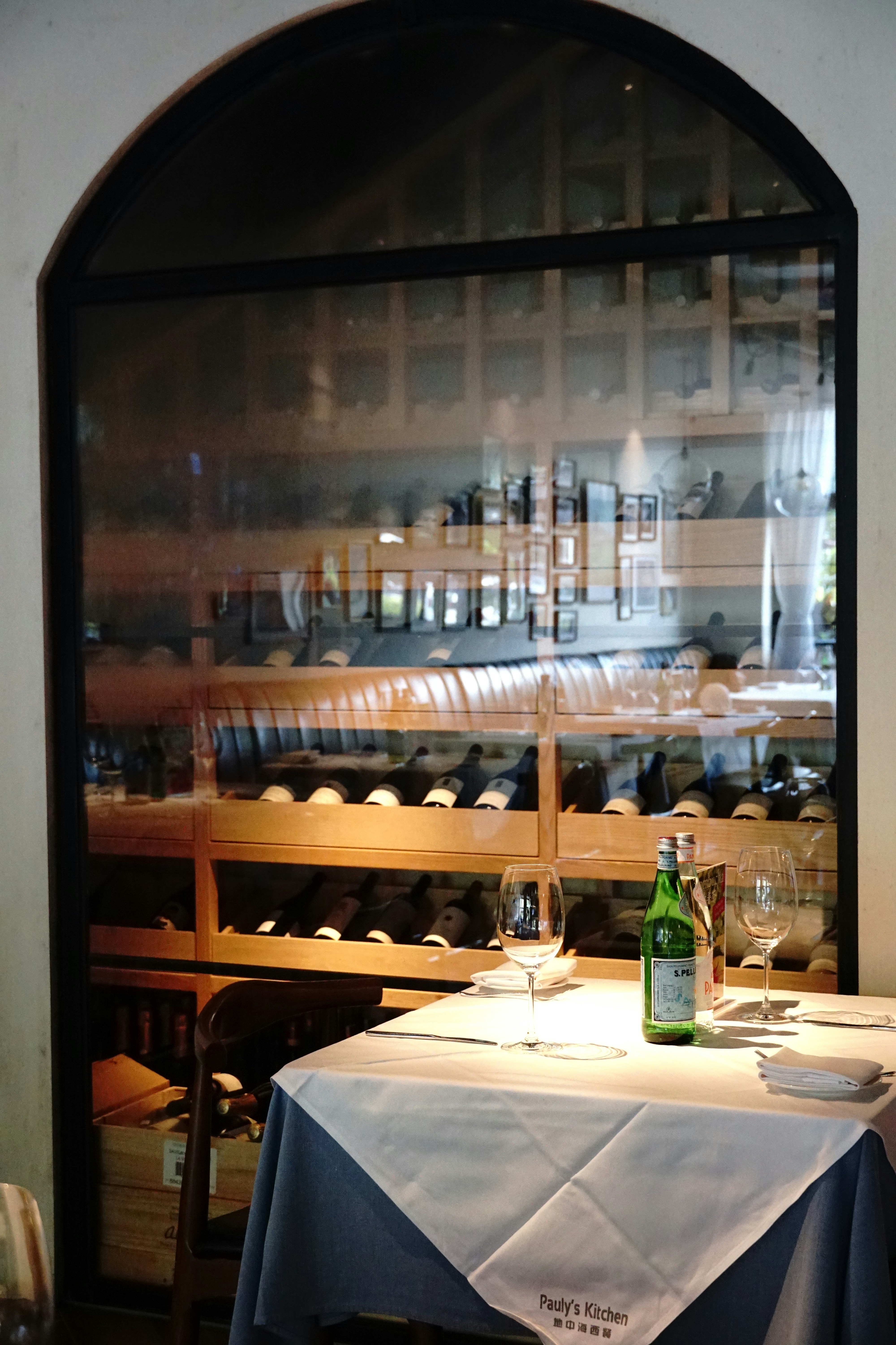 Tabletop Serenade: A Dining Scene Framed by Wine Racks