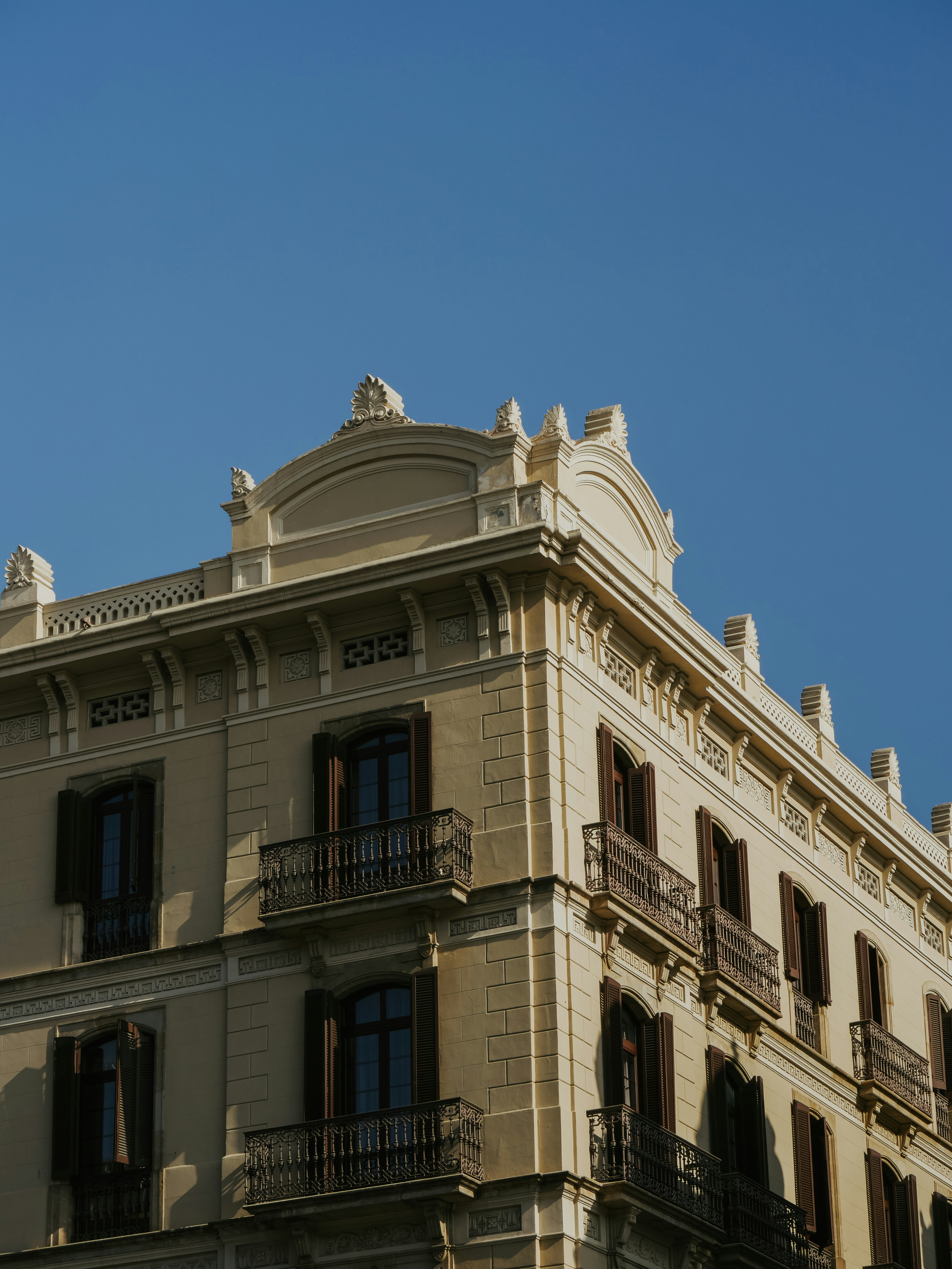 Historic buildings of Barcelona | Corner of a building against a clear blue sky