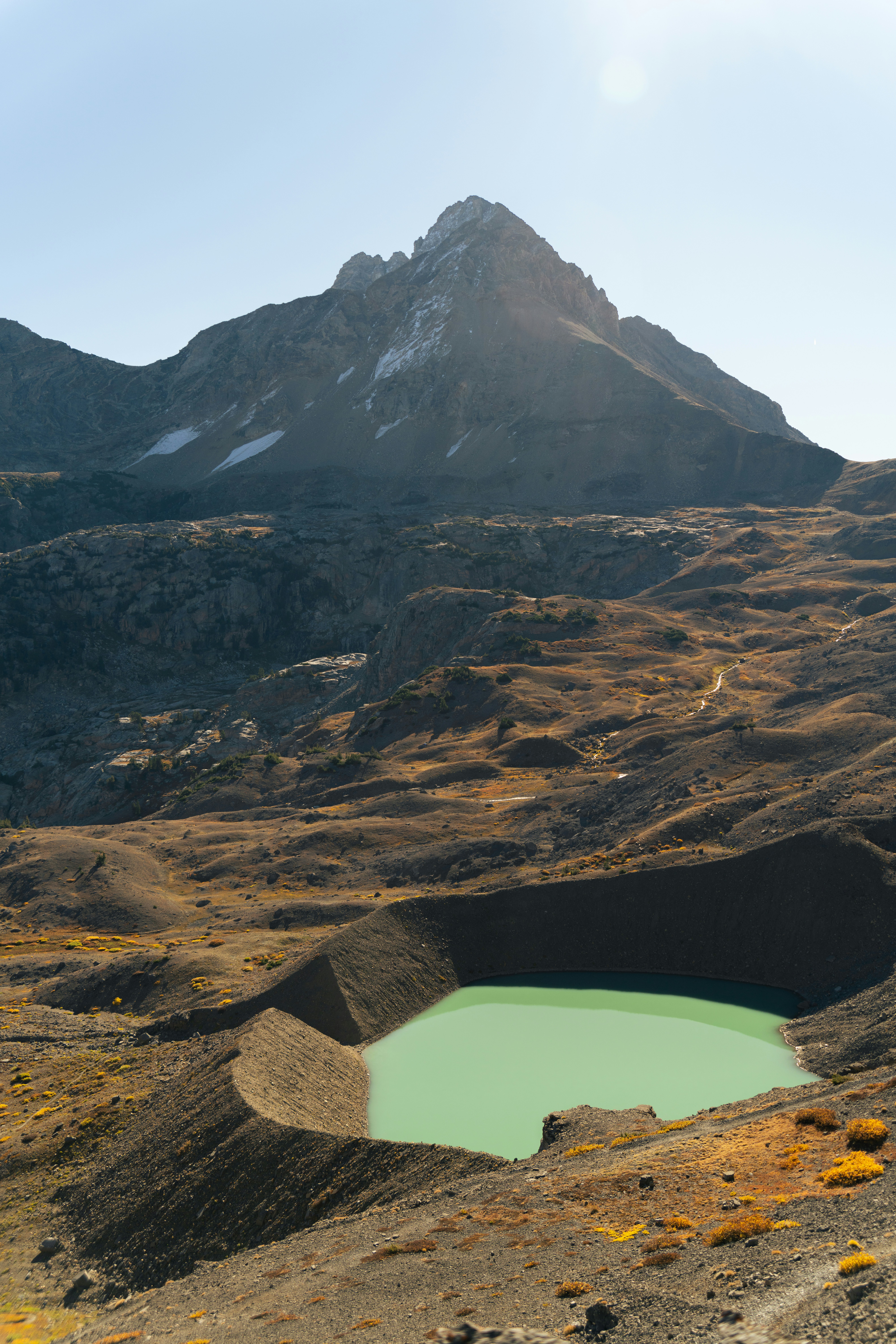 Emerald Crater Lake Nestled in a Rugged Alpine Basin