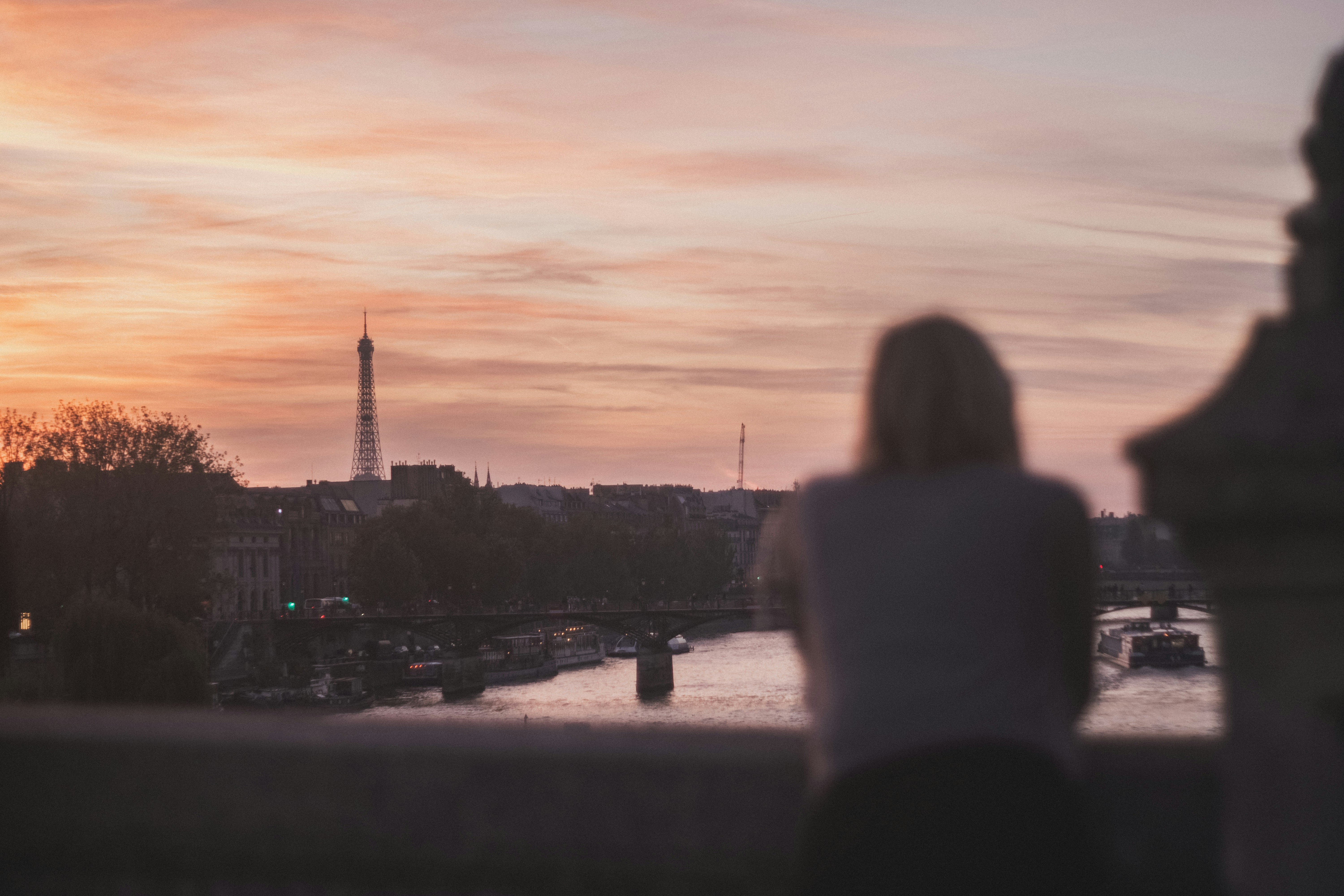 Woman watching sunset over paris cityscape