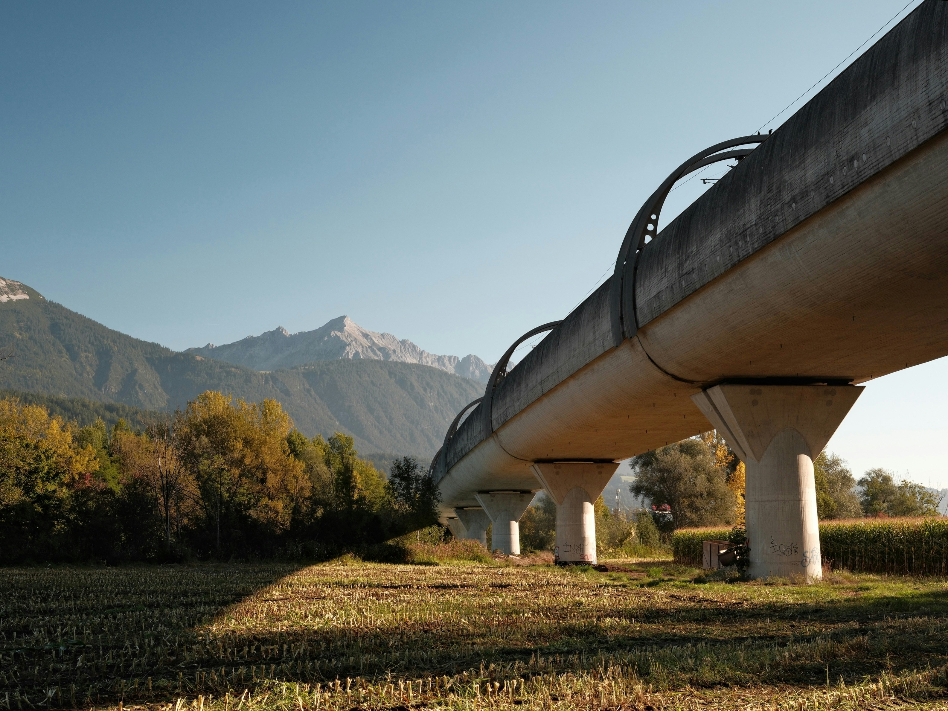 Train bridge before Karwendel Mountain | Concrete aqueduct bridge over a dry field