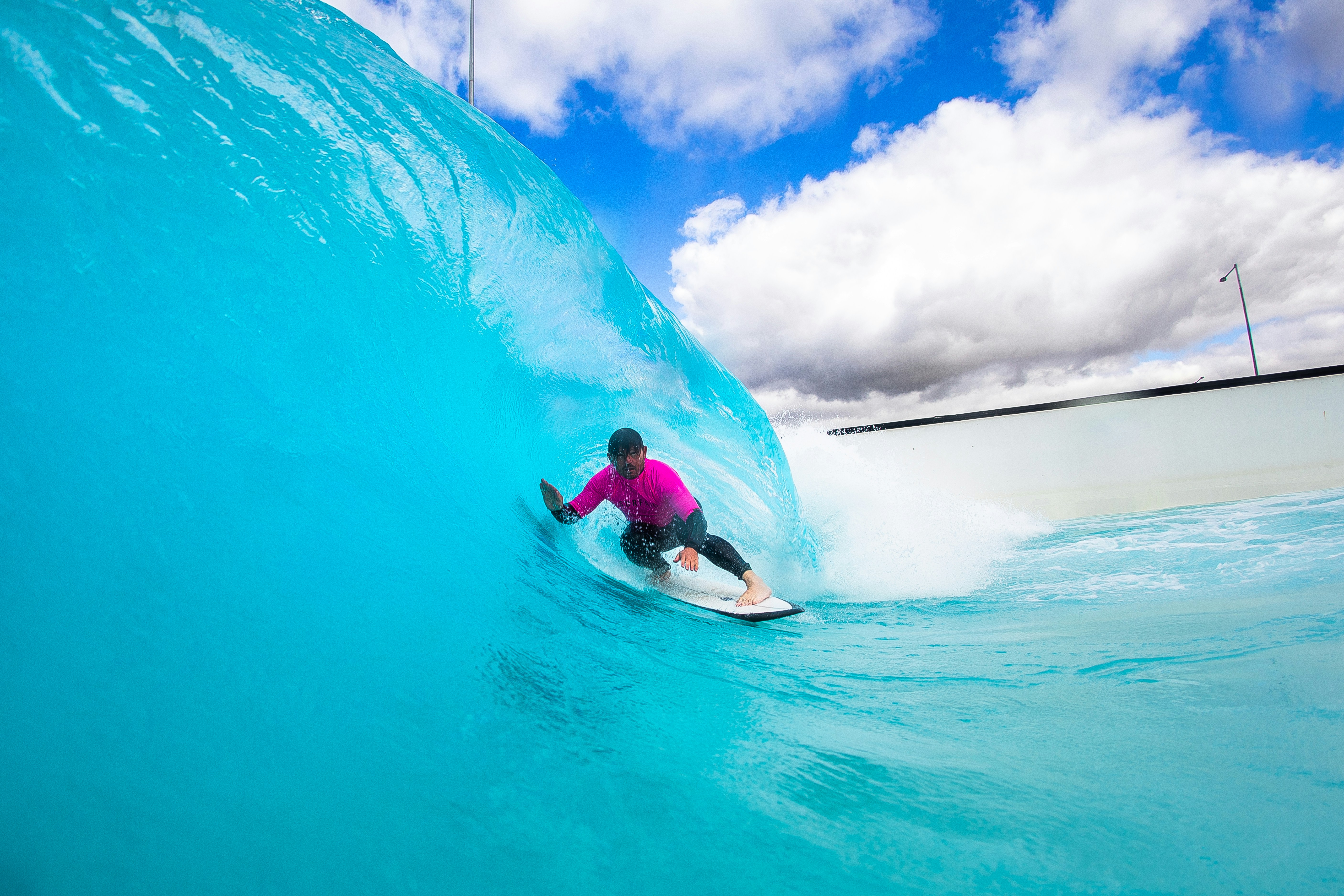 A Surfer Carves Inside a Turquoise Wave
