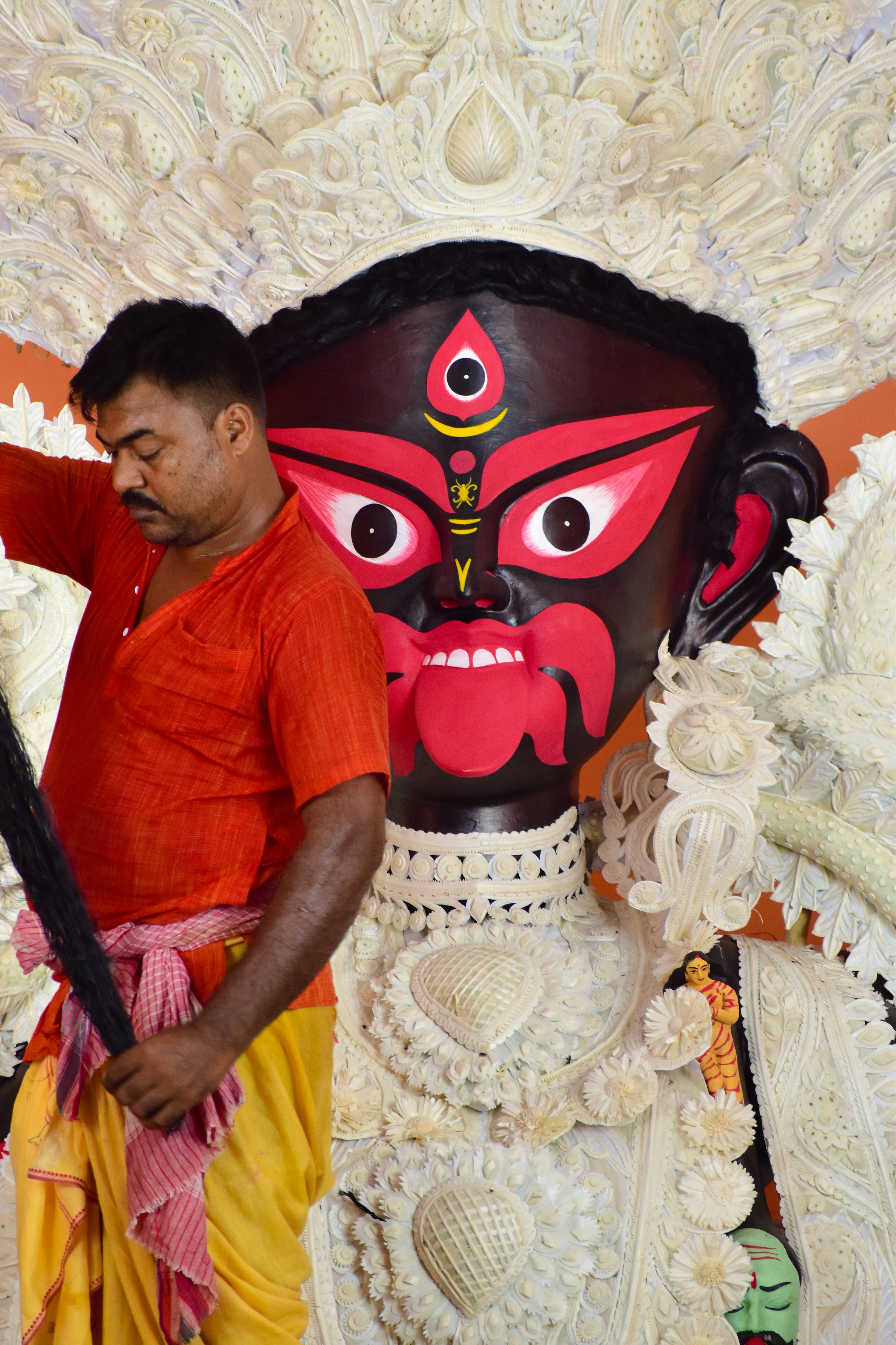 Man works on a large statue of a deity. photo – Free India Image on ...