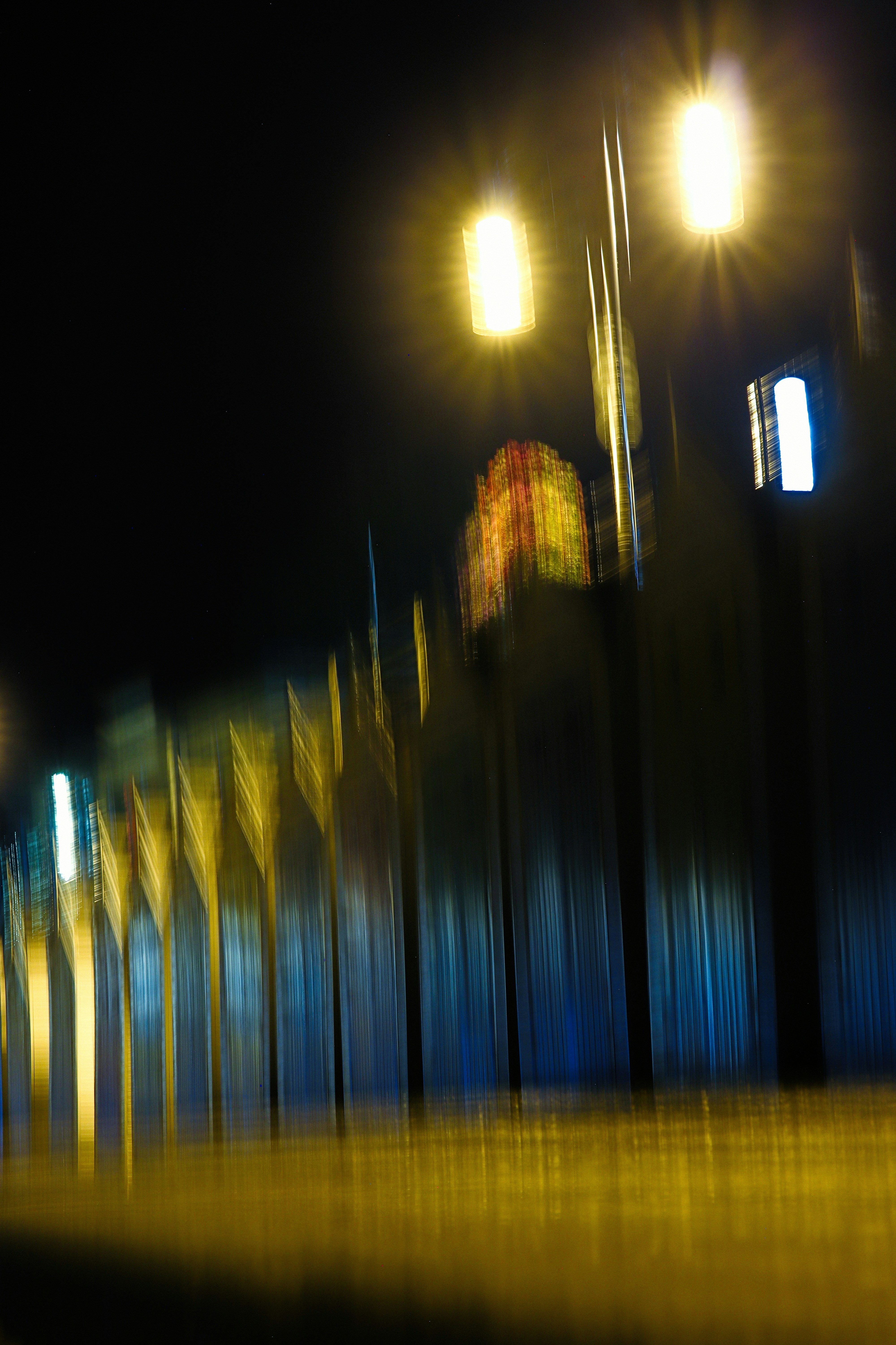 Abstract of beach huts on Lyme Regis beach early in the morning | Blurred streetlights illuminate a wet city street at night.