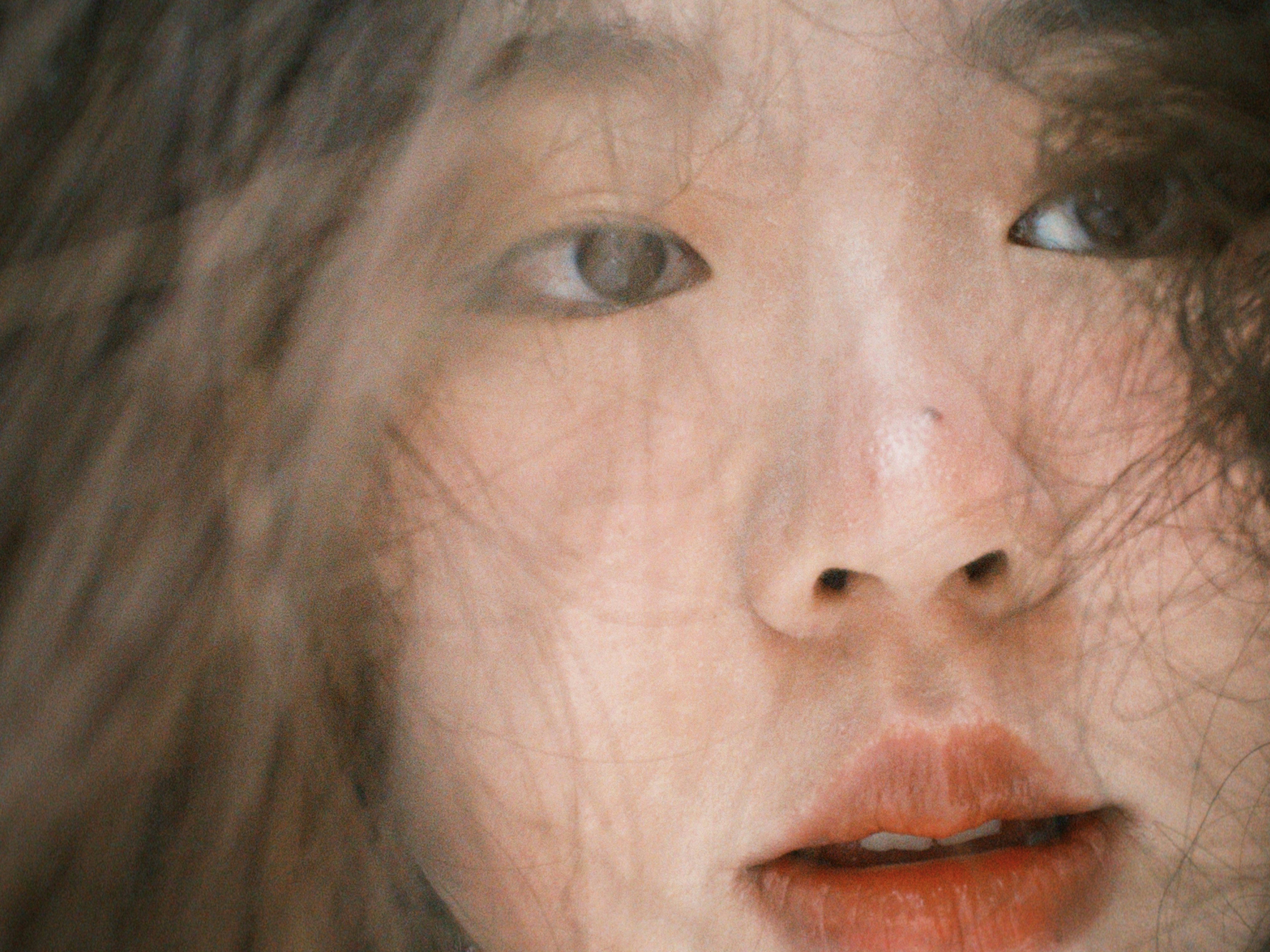 Close-up of a young woman's face with windblown hair