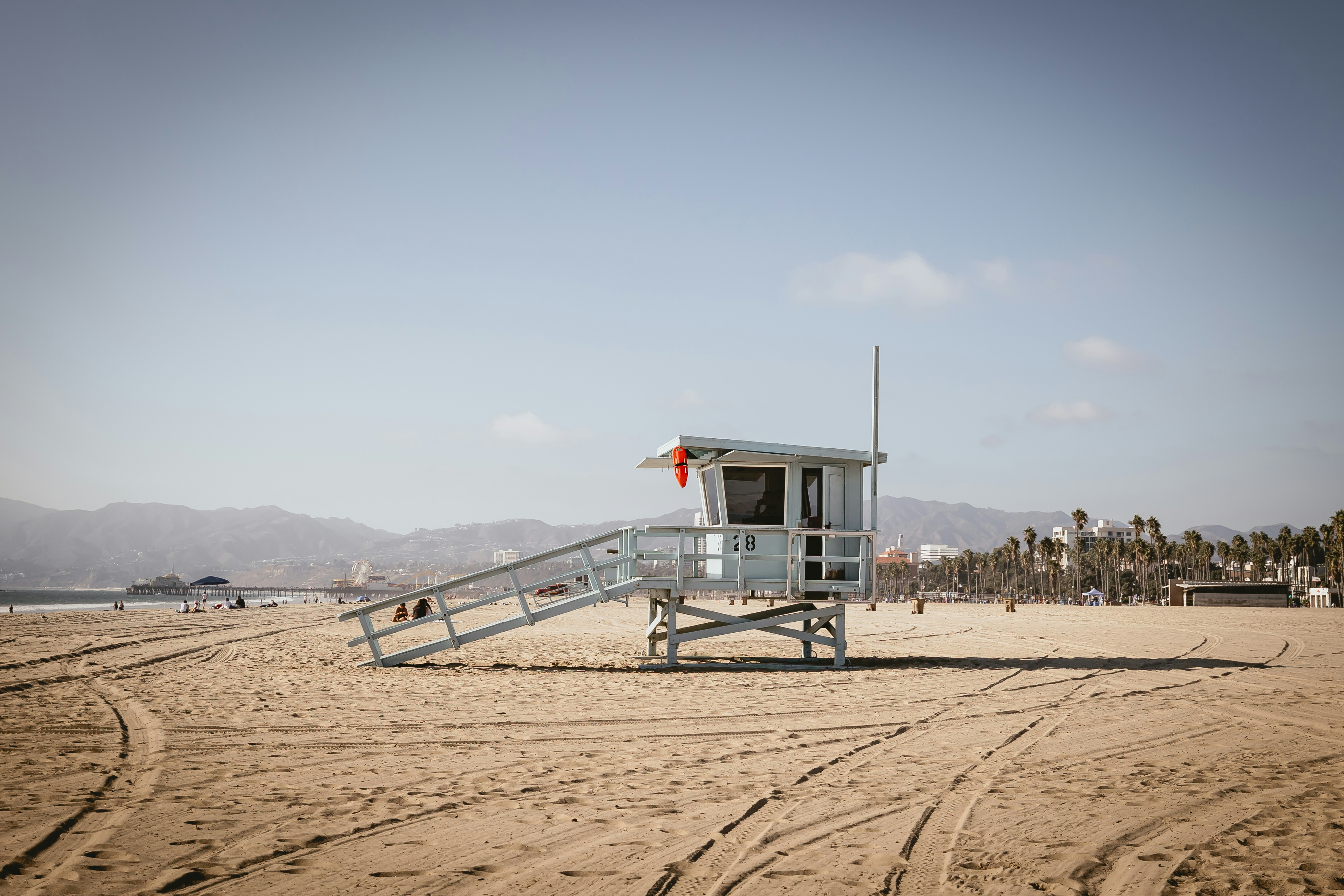 Lifeguard tower on a sandy beach with mountains