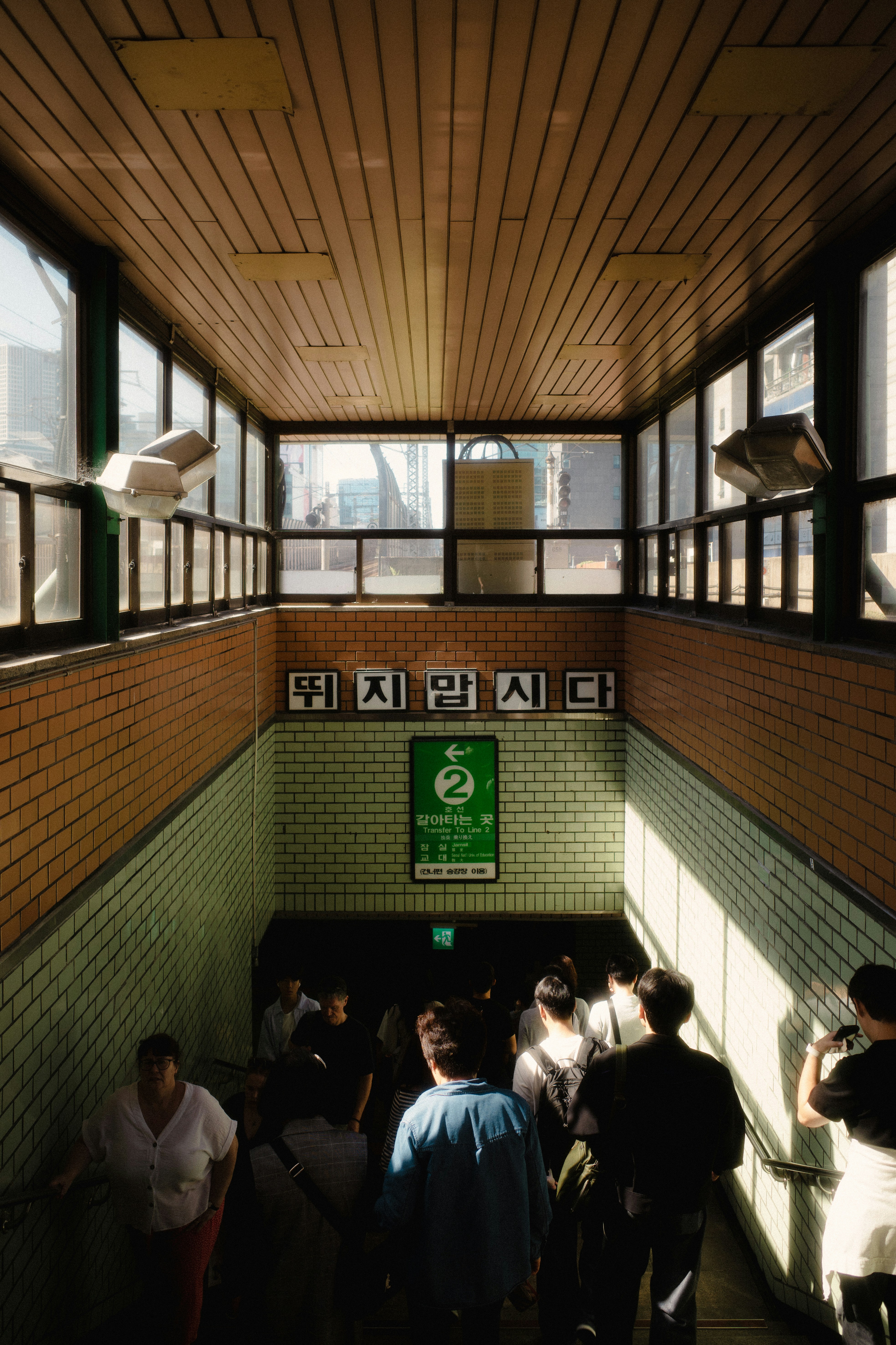 Seoul, SeongSu Station, South Korea | People descending stairs into a subway station.