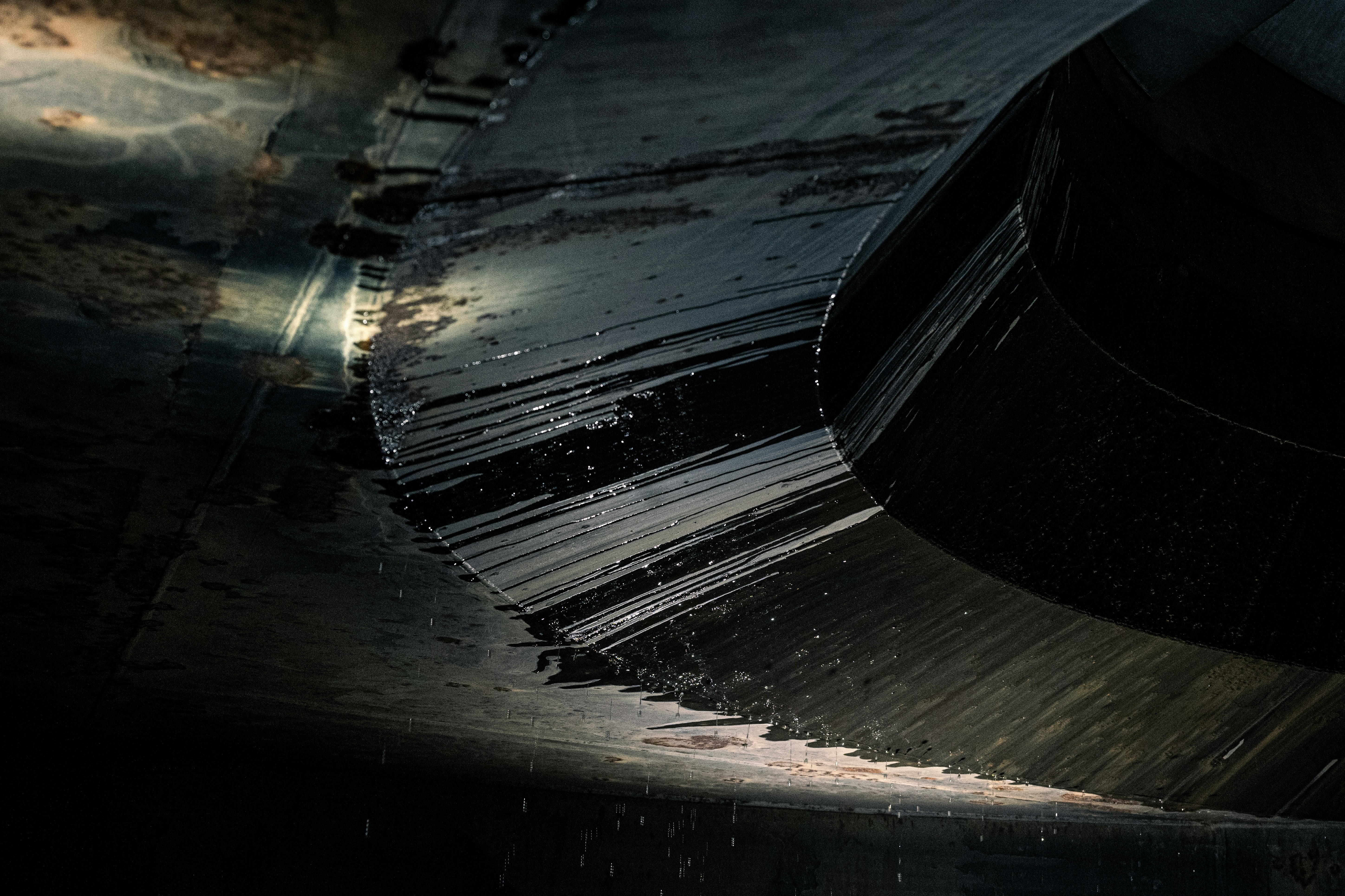 Close-up of debris falling inside a dark pipe photo – Free Concrete ...