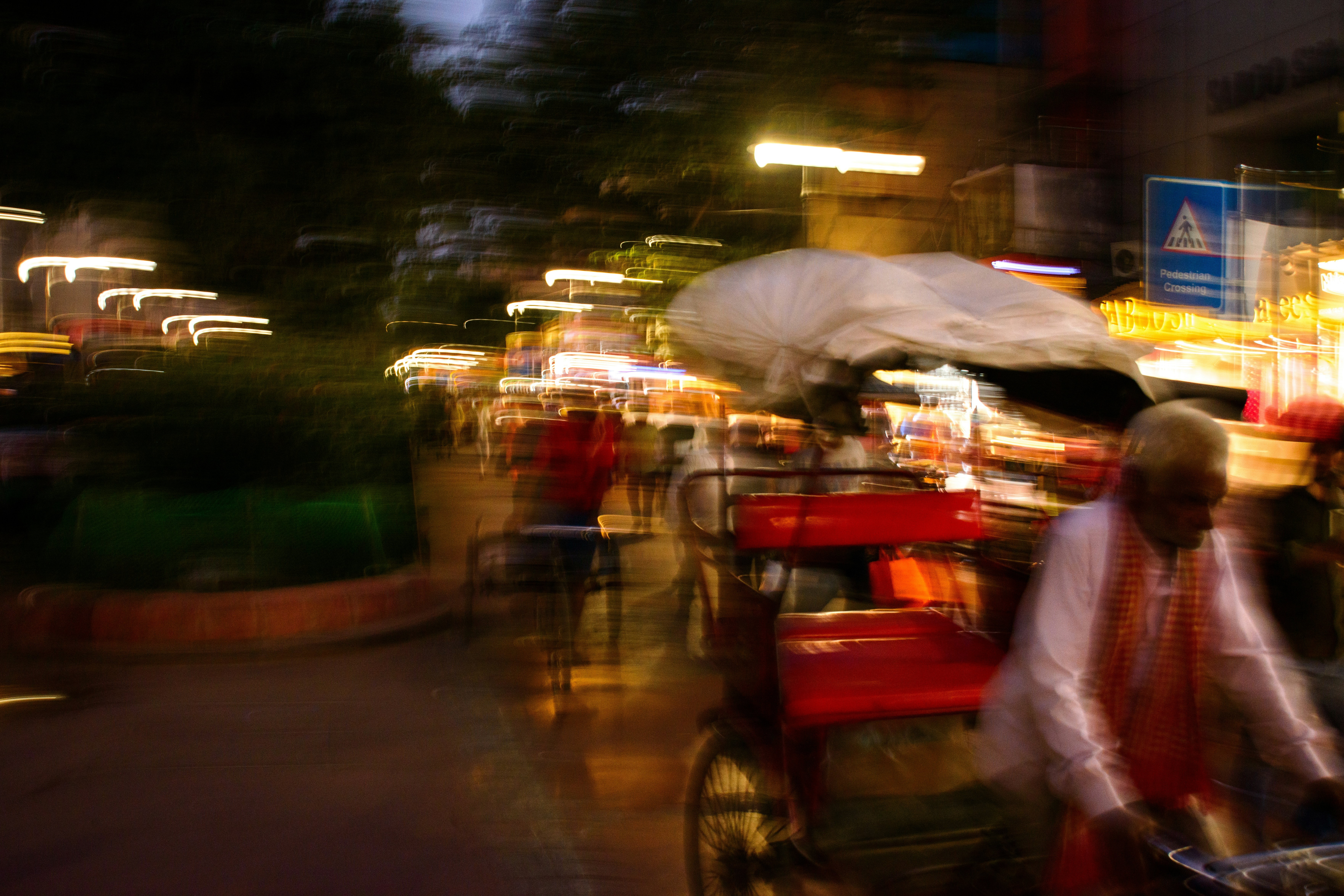 A cycle rickshaw goes by me and everyone else in the chaos of Chandni Chowk