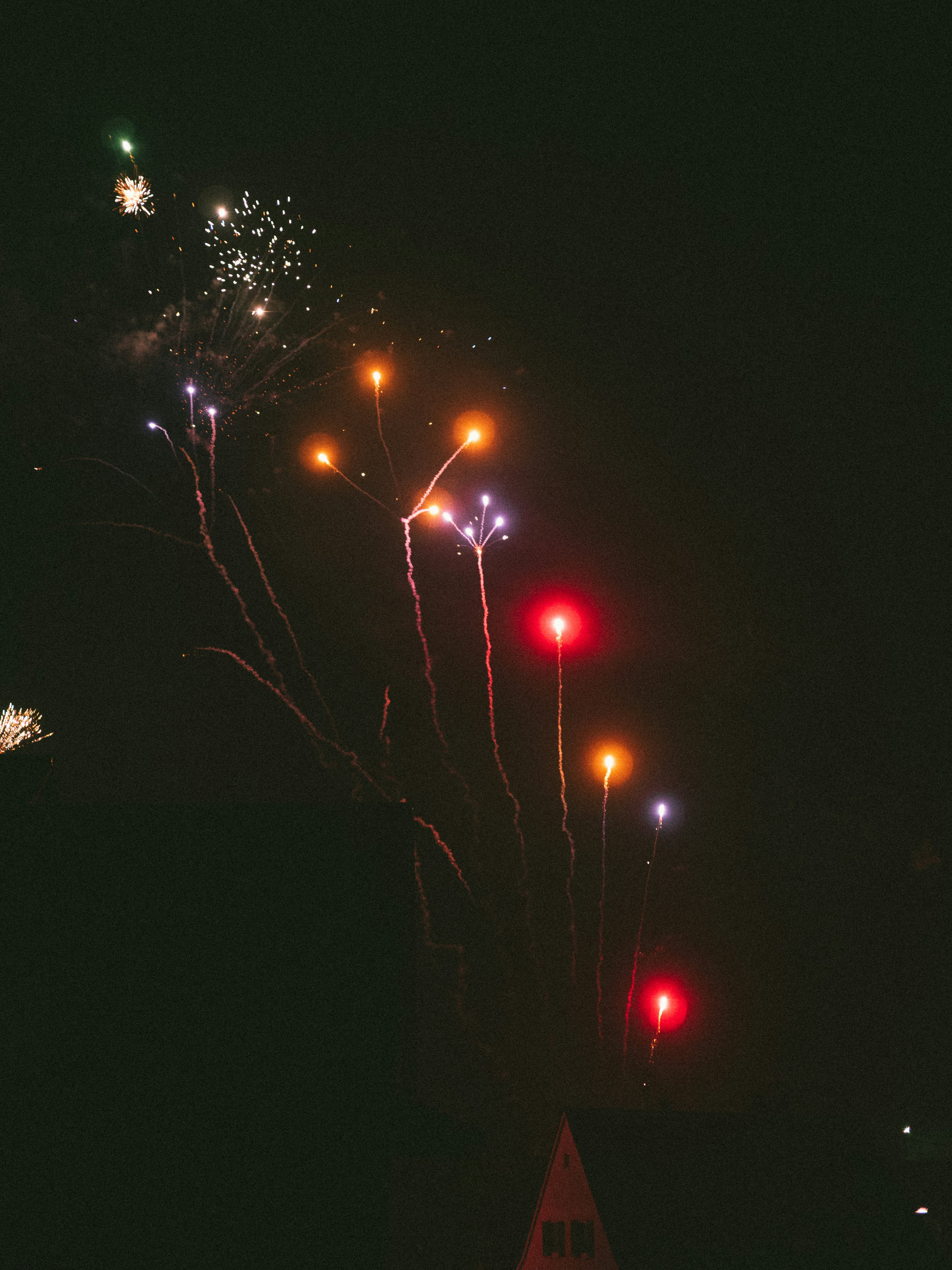 Vertical Firework Chorus Over a Quiet Night Street