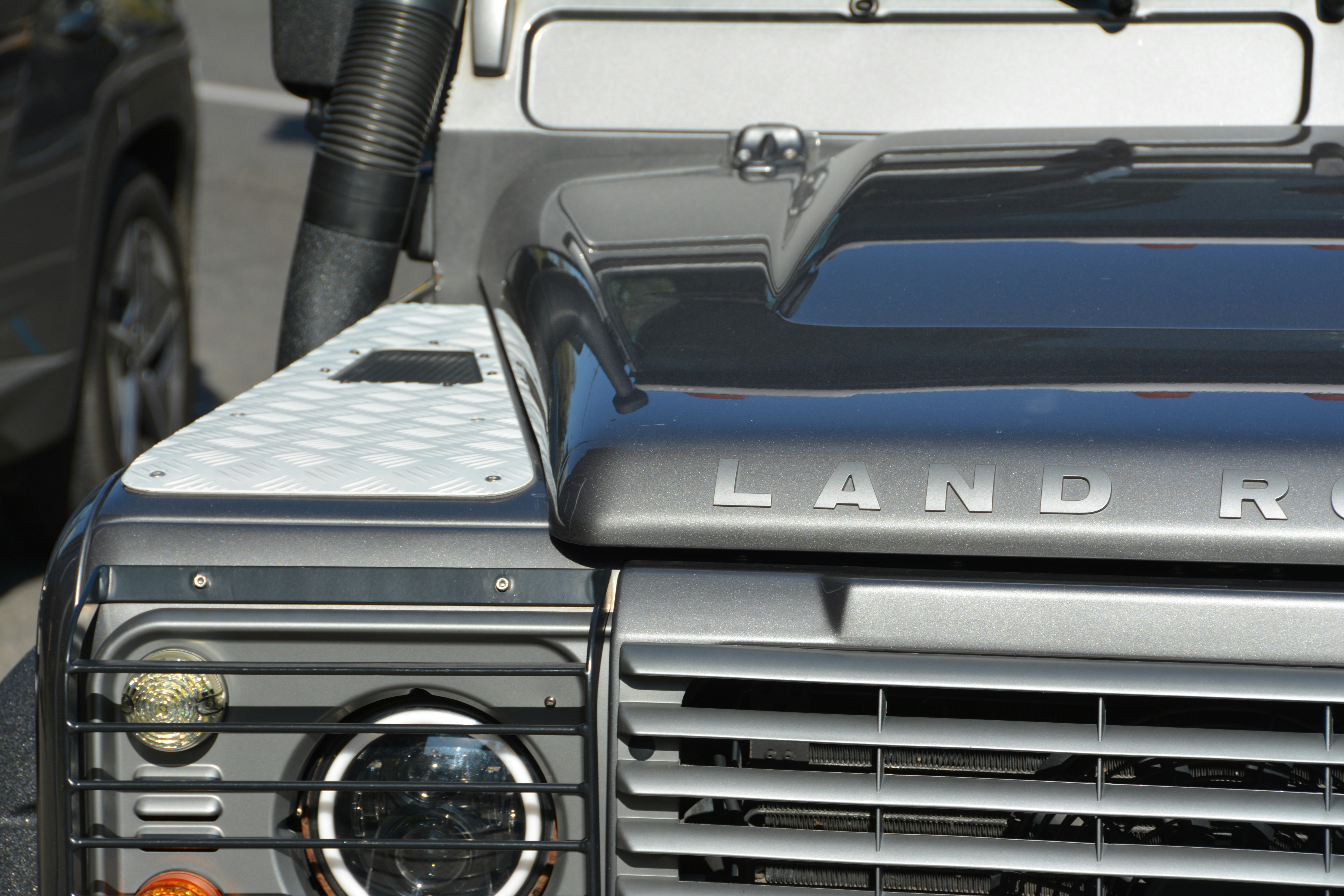 Rugged Gaze: Front Grille and Round Headlight of a Land Rover