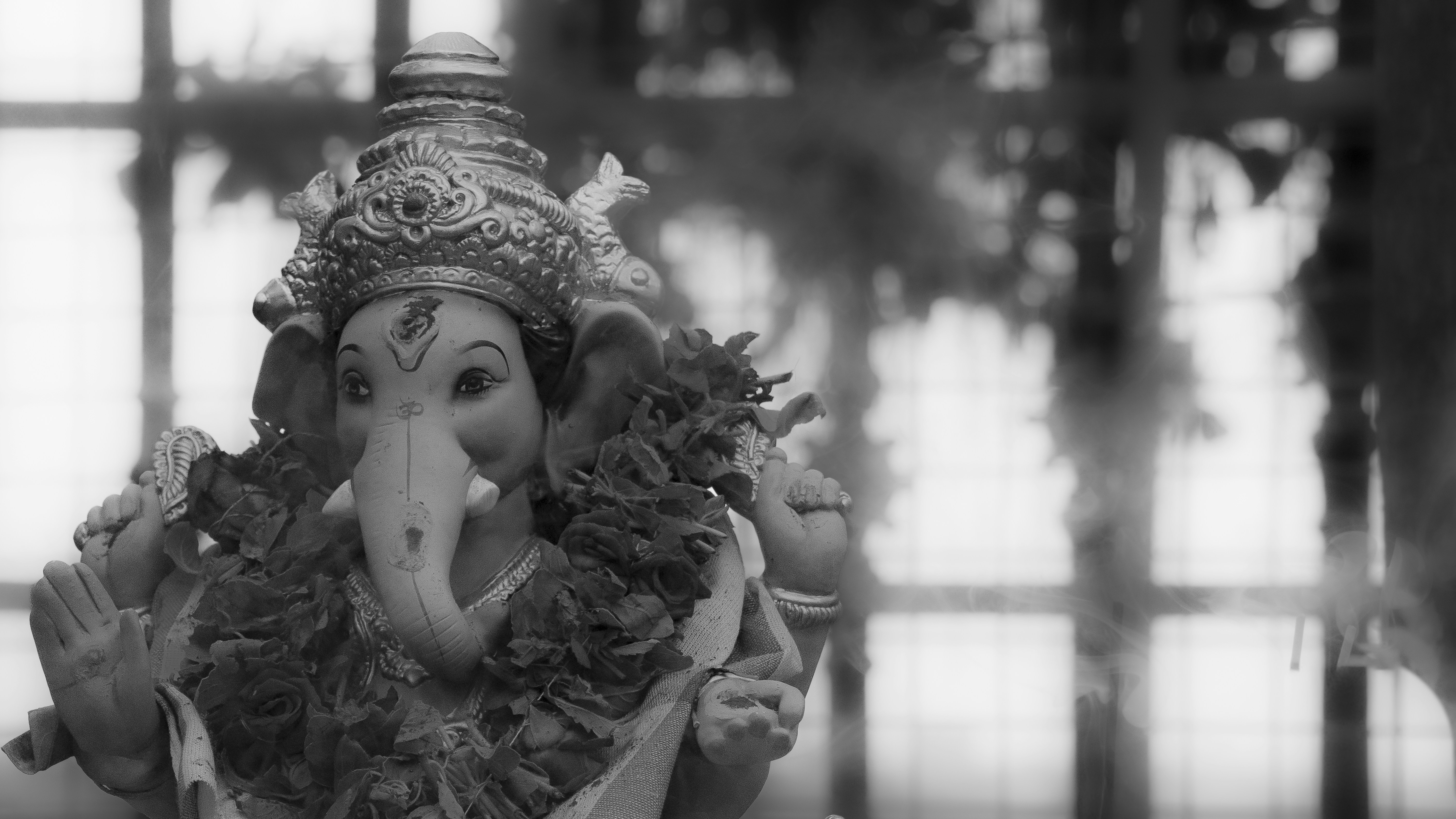 Garlanded Ganesha in Quiet Monochrome by Window Light