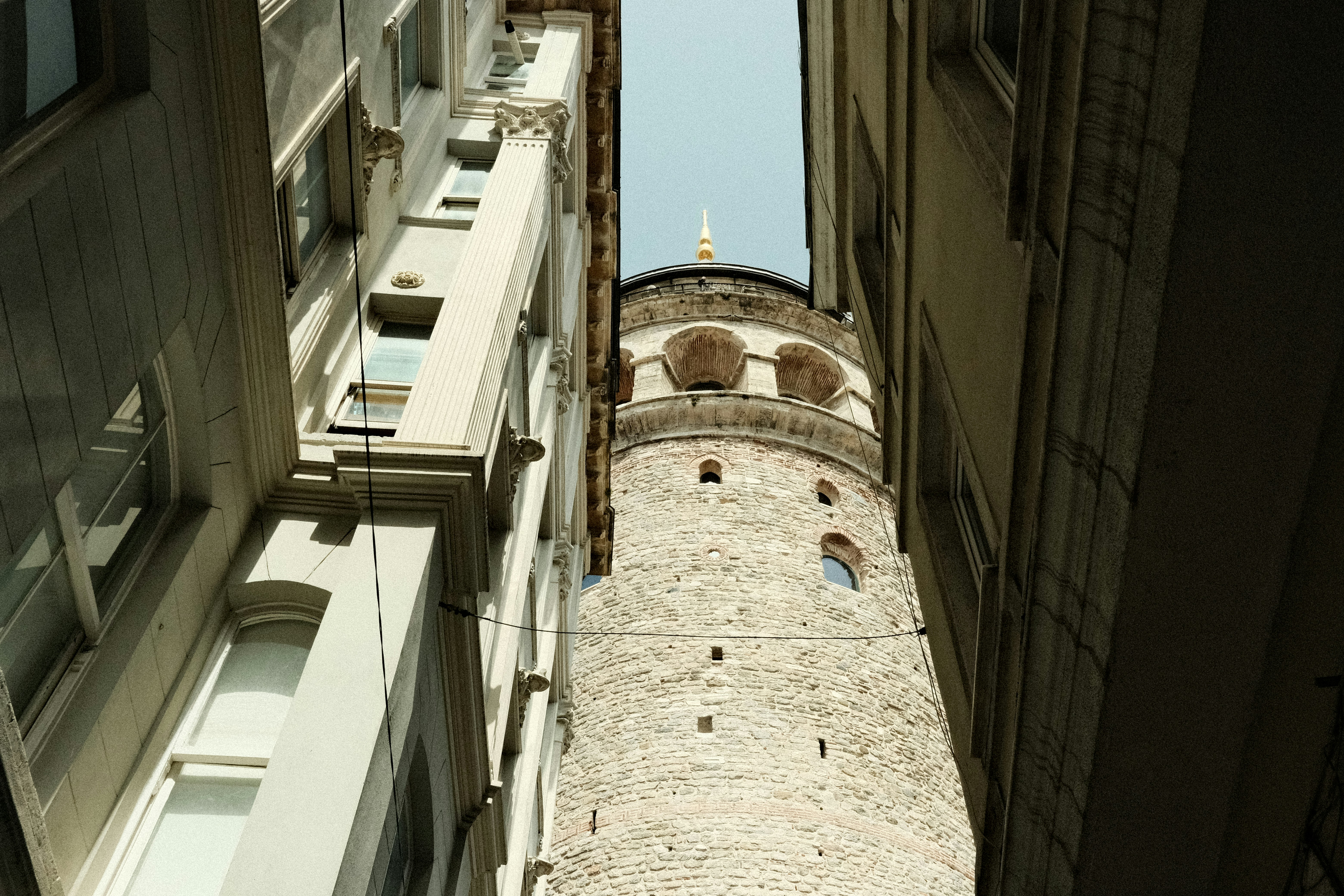 Galata tower viewed between tall buildings