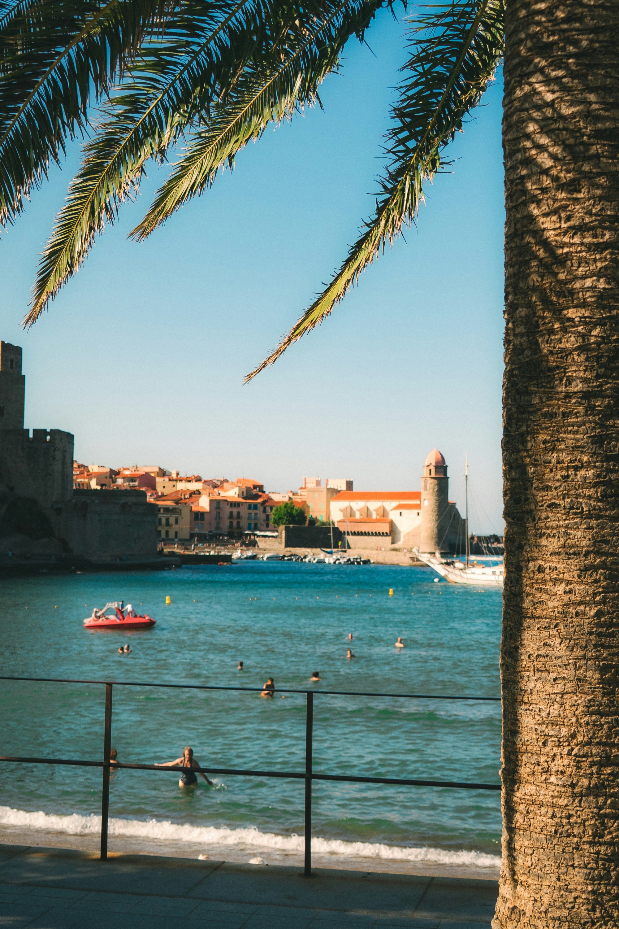 Coastal town with people swimming in the bay.