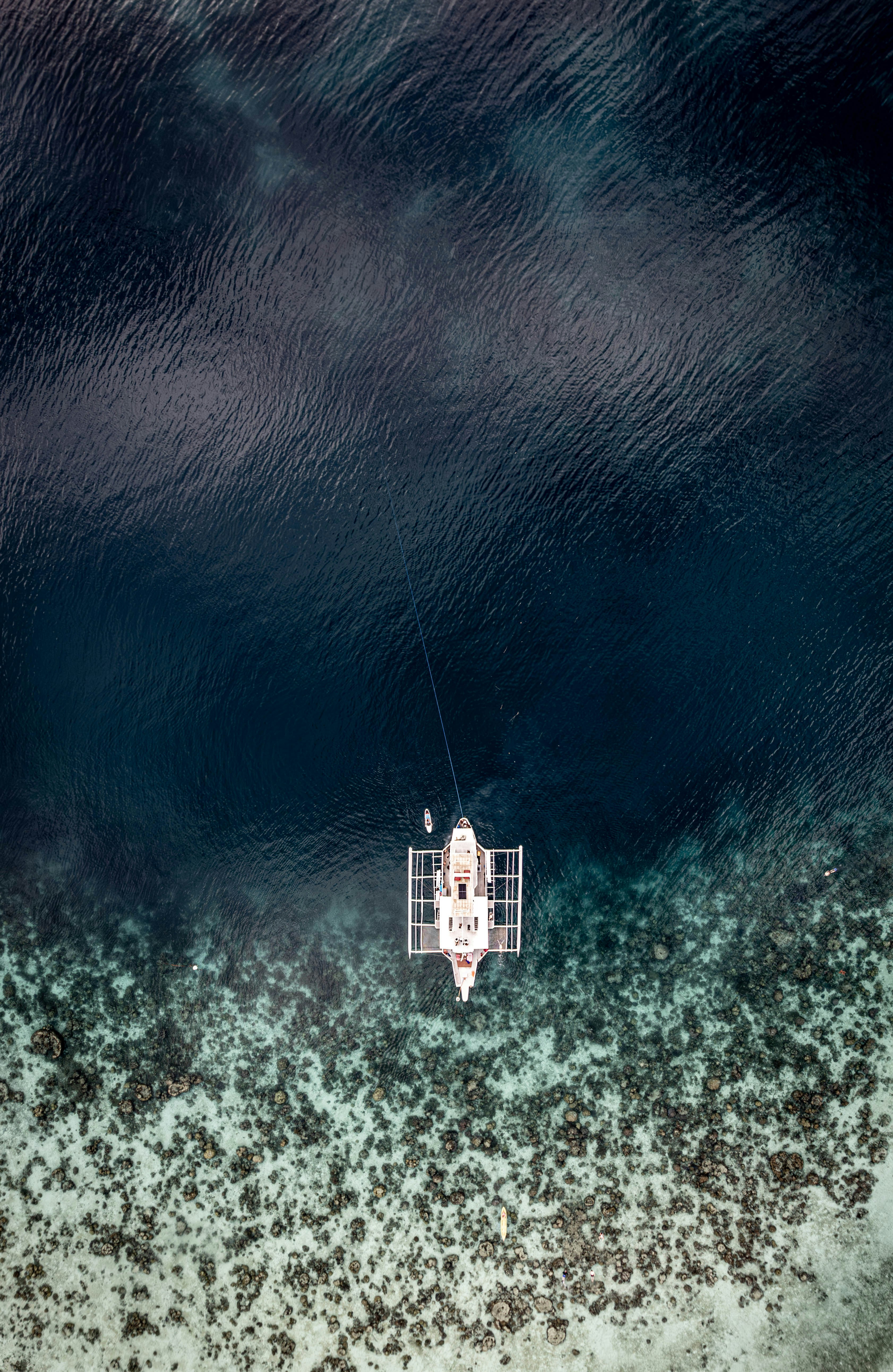 Above the Reef: A White Drone Hovering Over Turquoise Shallows