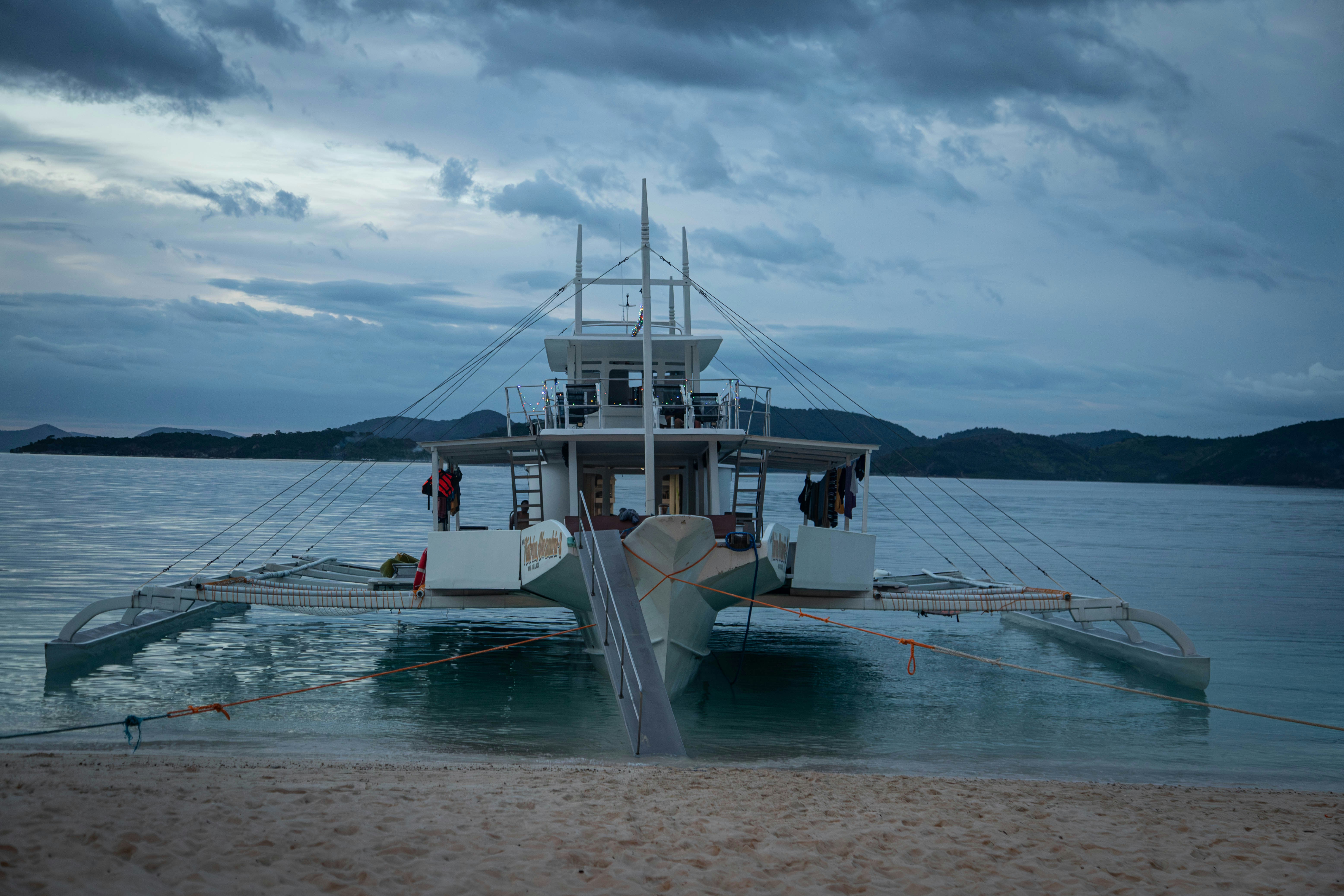 Symmetry of Arrival: Outrigger Catamaran at the Quiet Shore