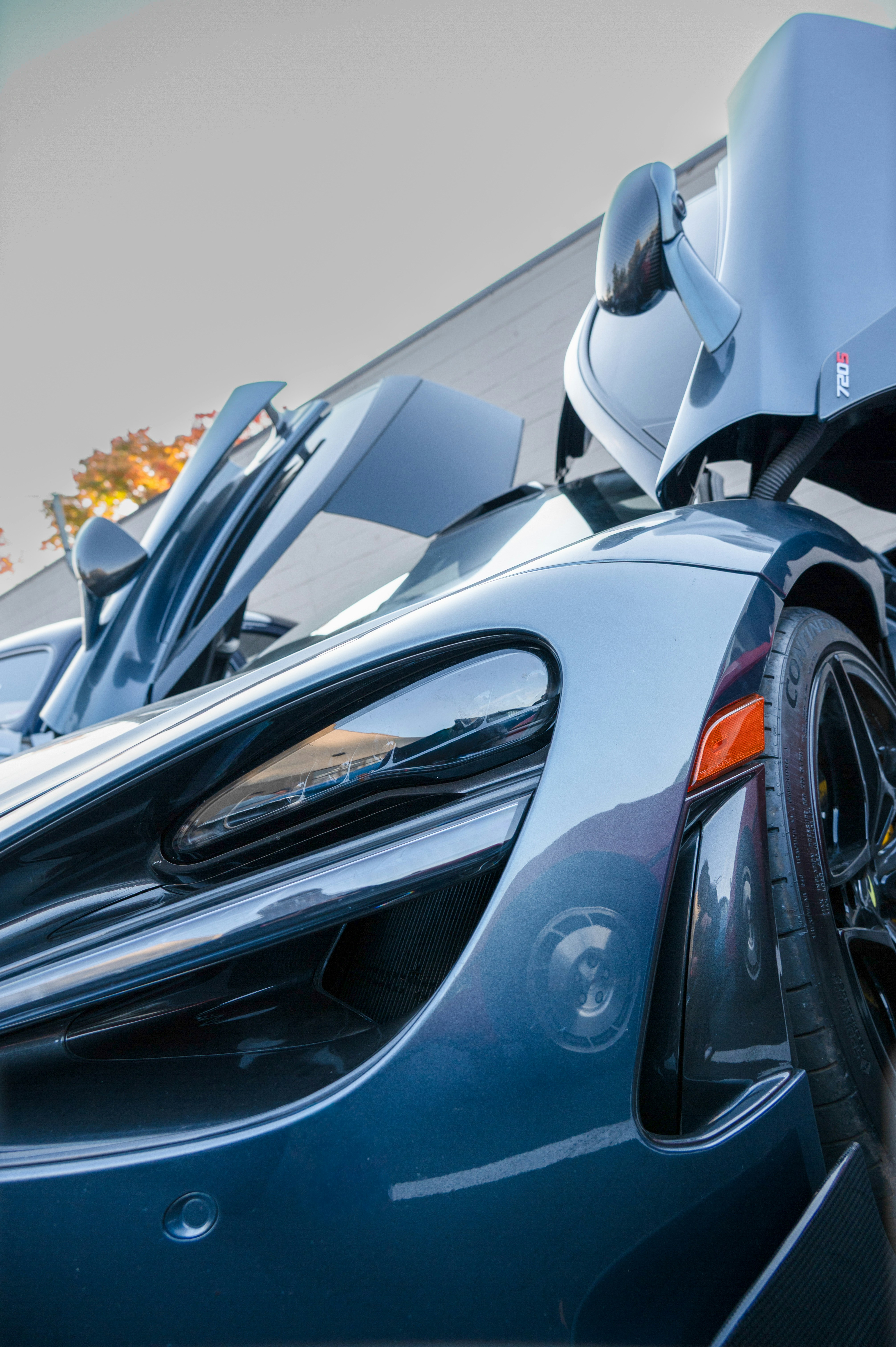 Blue McLaren: Scissor doors and sculpted curves under soft light