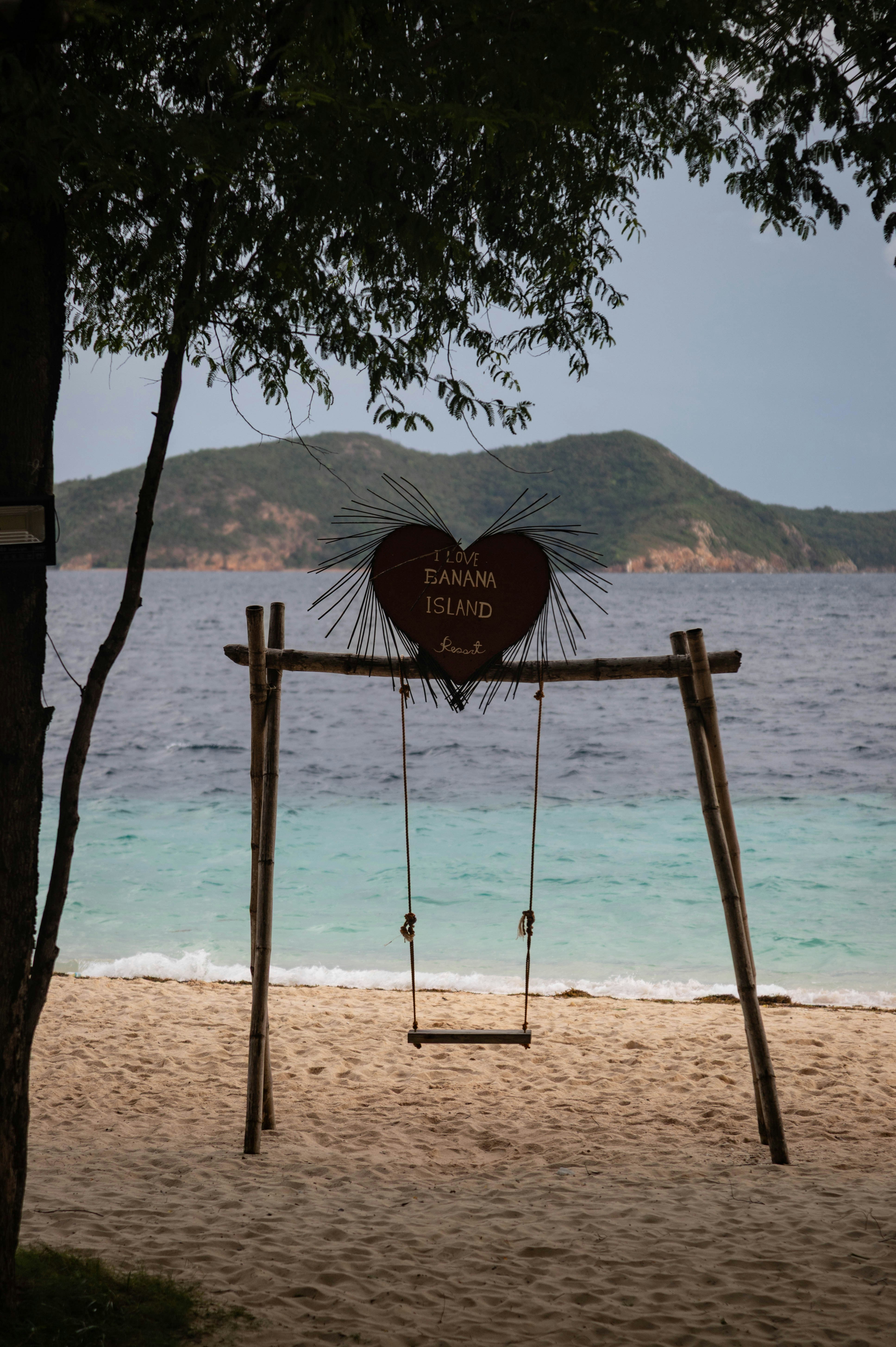 Heart Sign and Swing on Banana Island Beach, Framed by Turquoise Seas