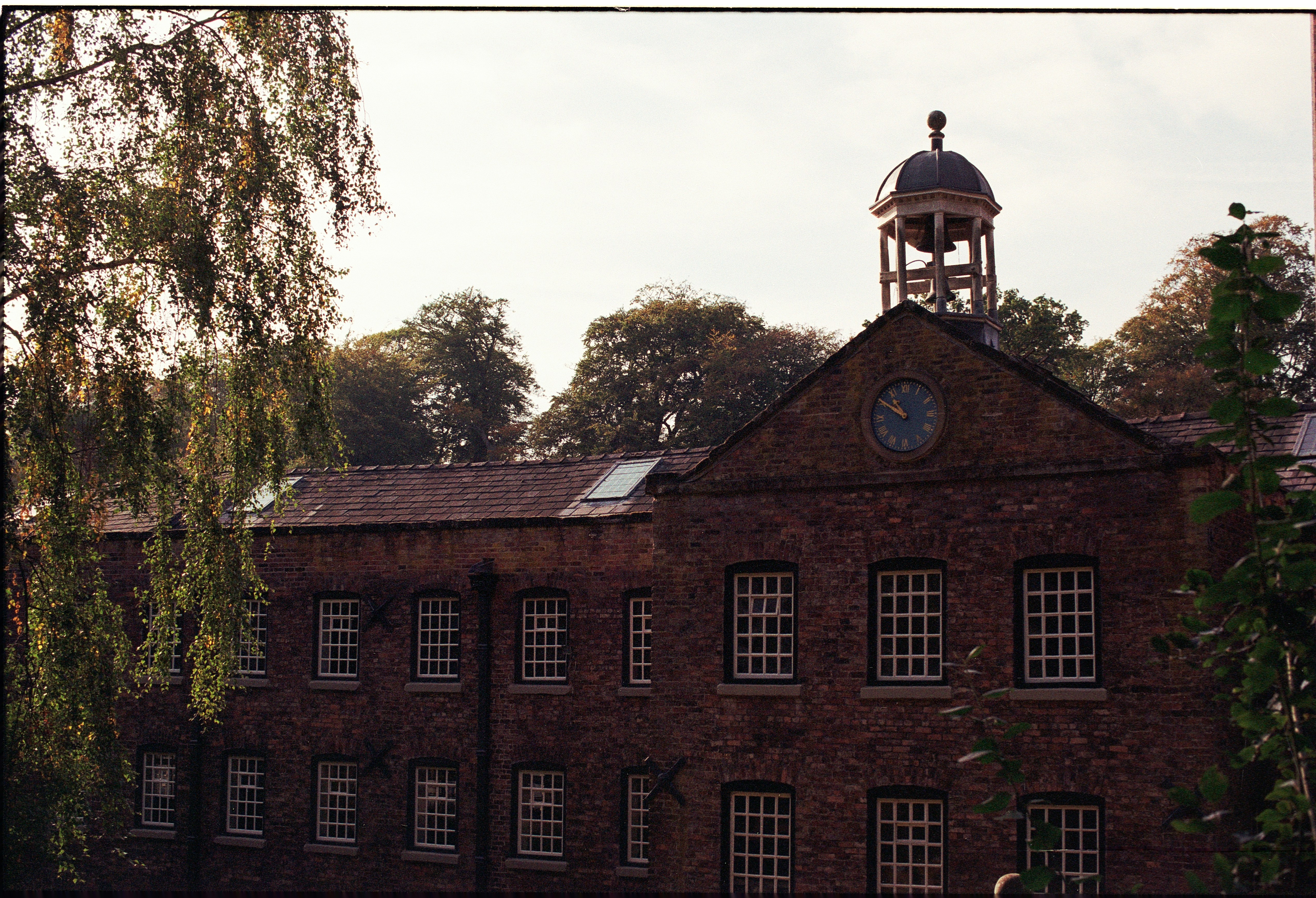 Clock Tower Quiet: Autumn Light on a Red Brick Campus Facade