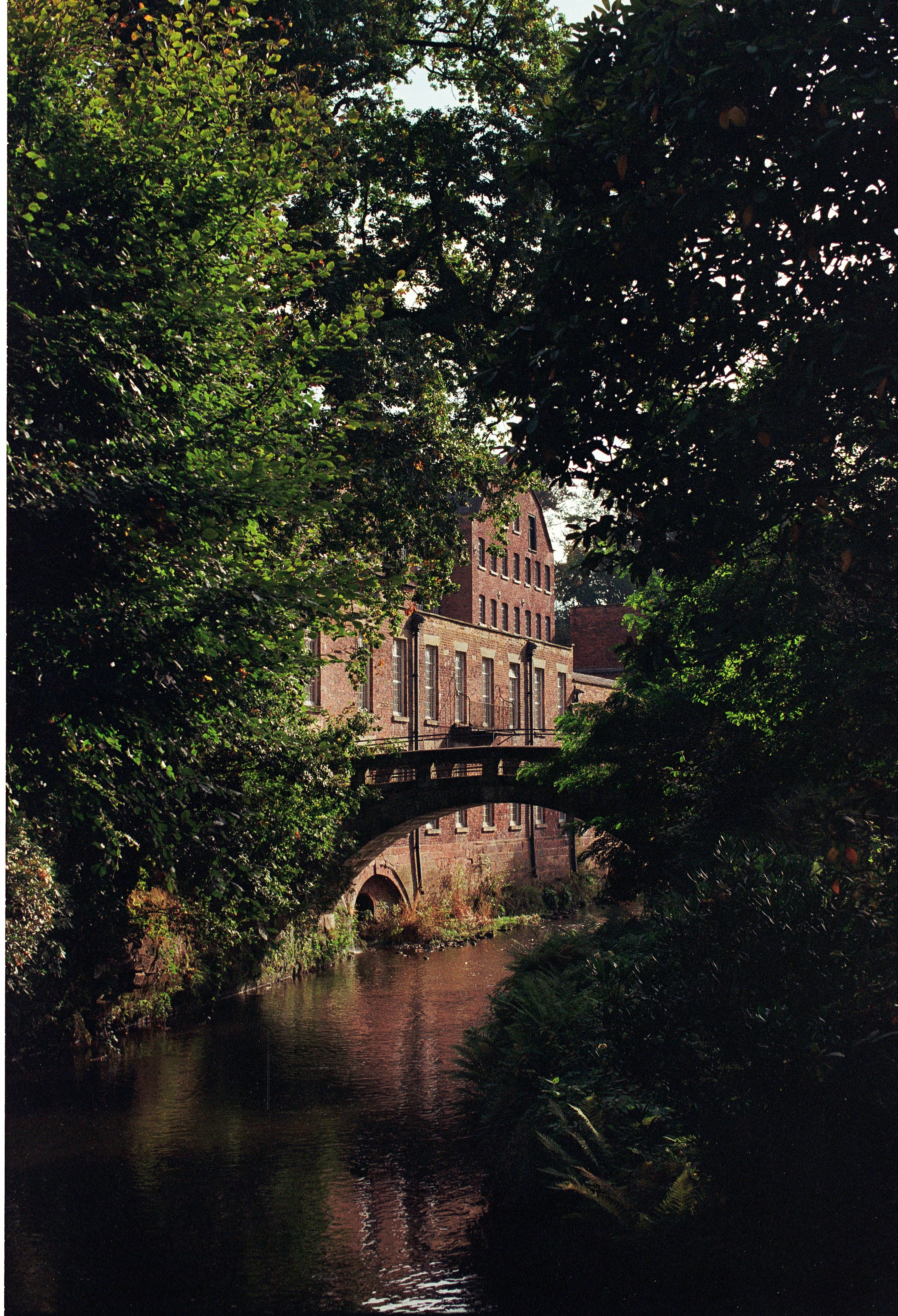 Brick building with arched bridge over canal.