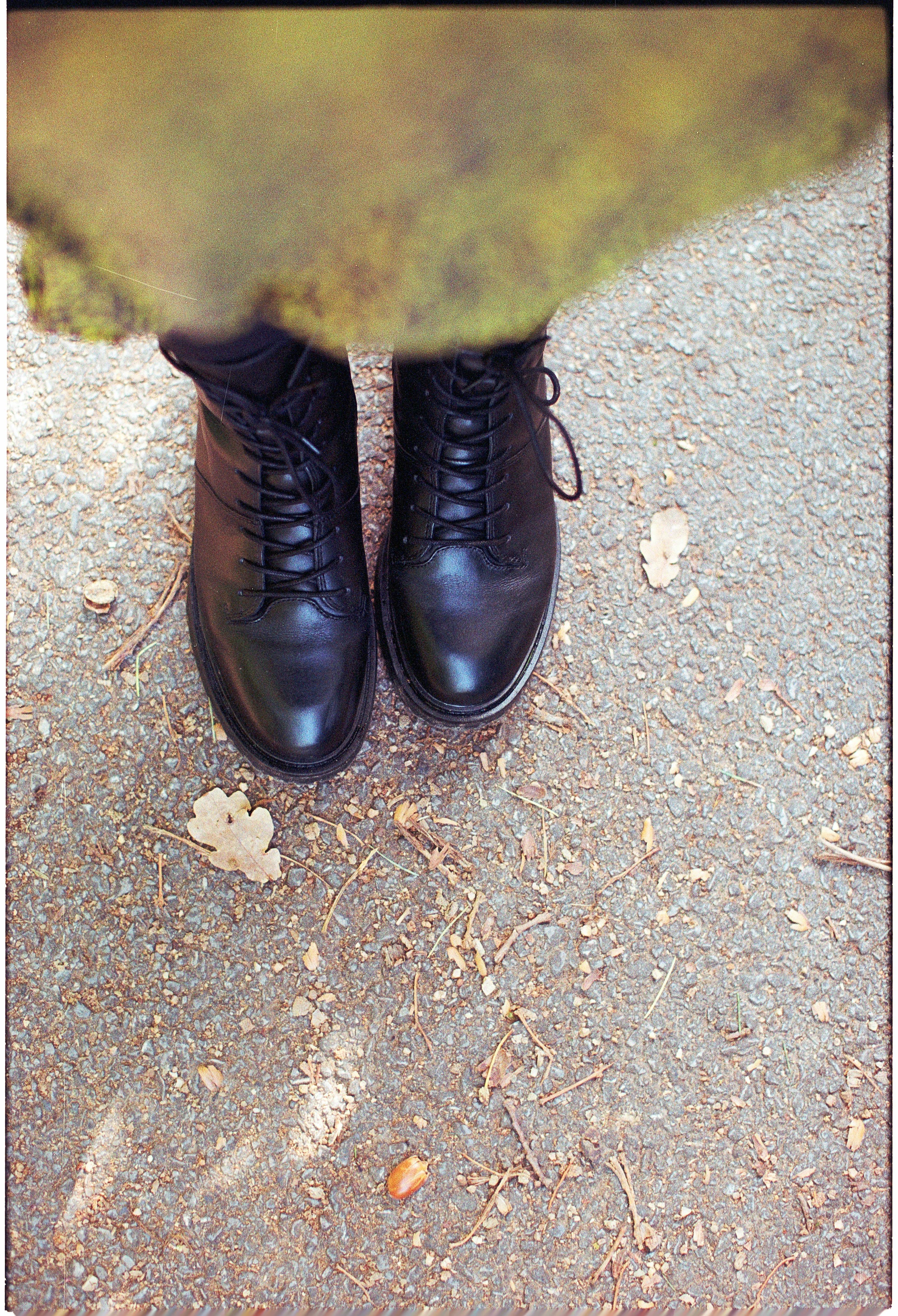 Black lace-up boots on a gravel path