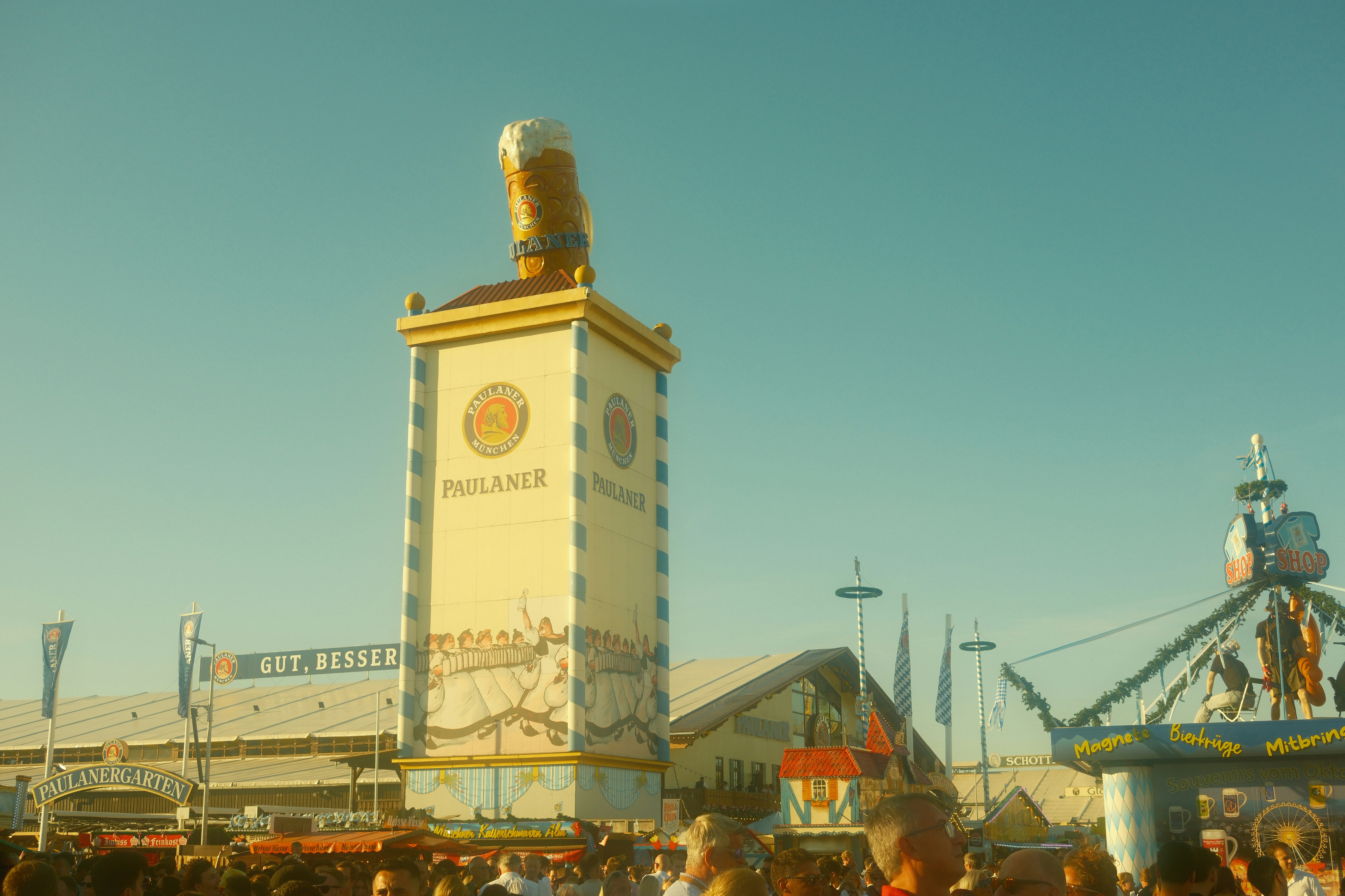 Sun-Soaked Paulaner Tower Over a Bustling Beer Festival