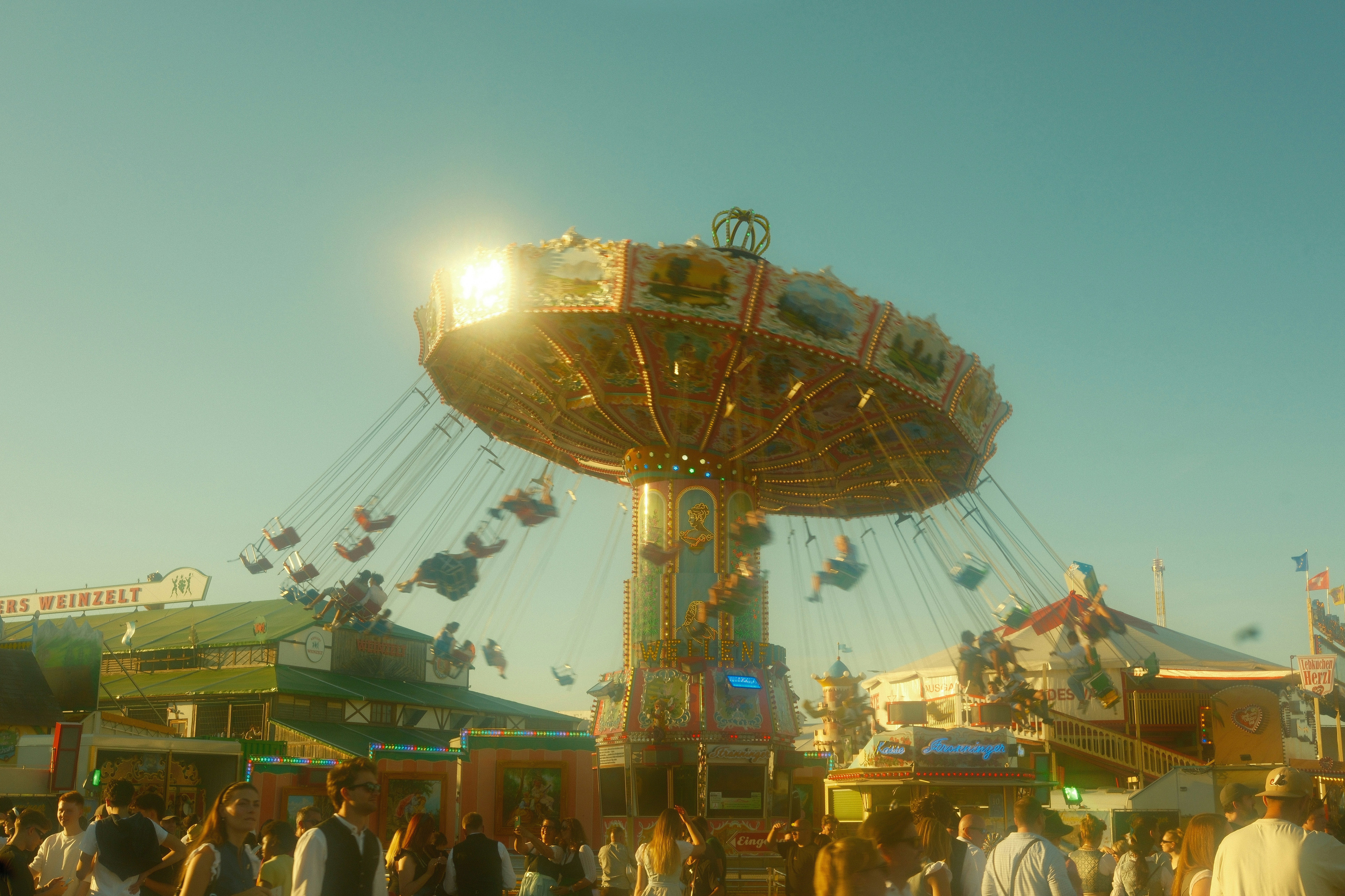 Golden Hour Swing: A Moment Above the Crowded Midway