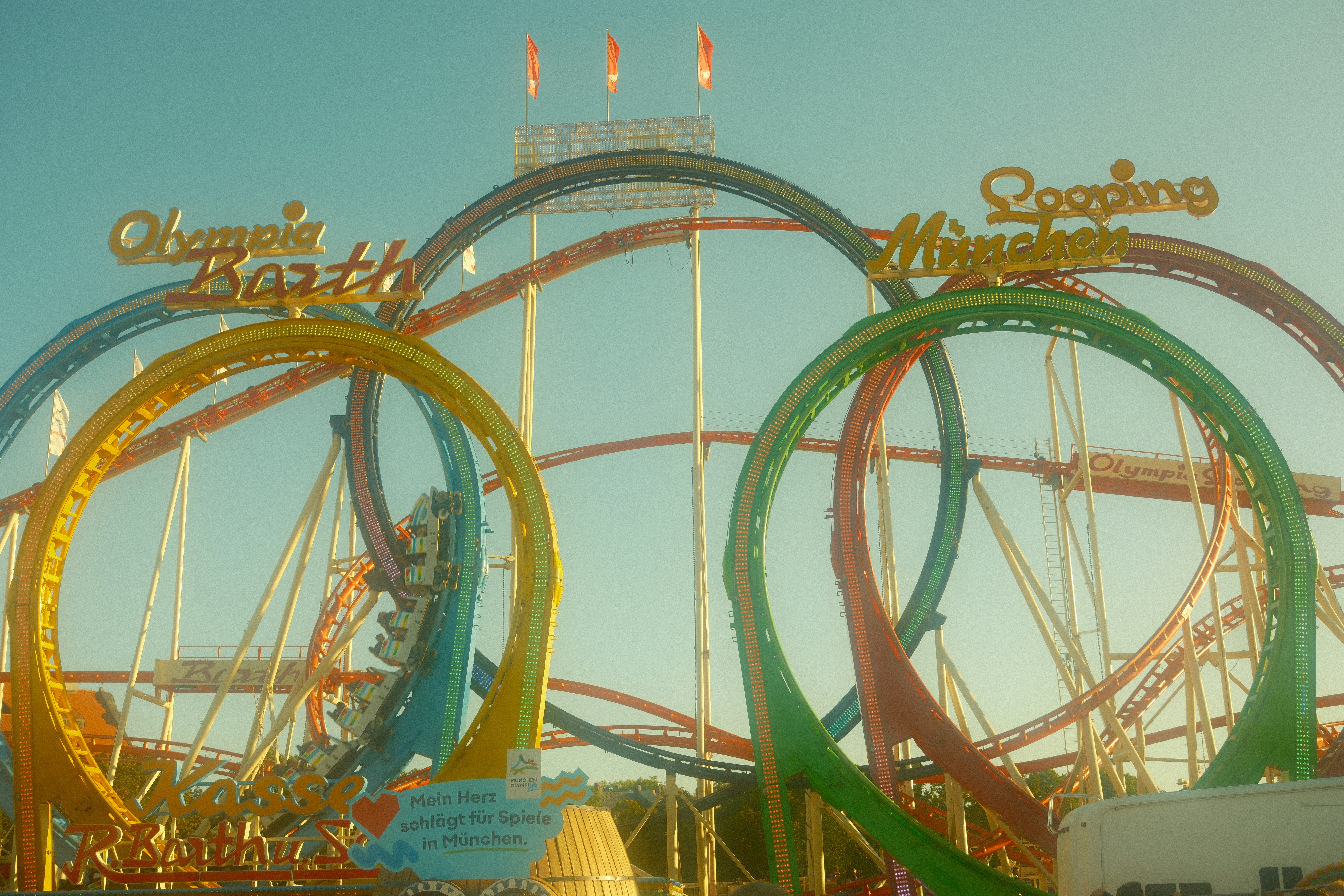 Colorful roller coaster with loops against blue sky