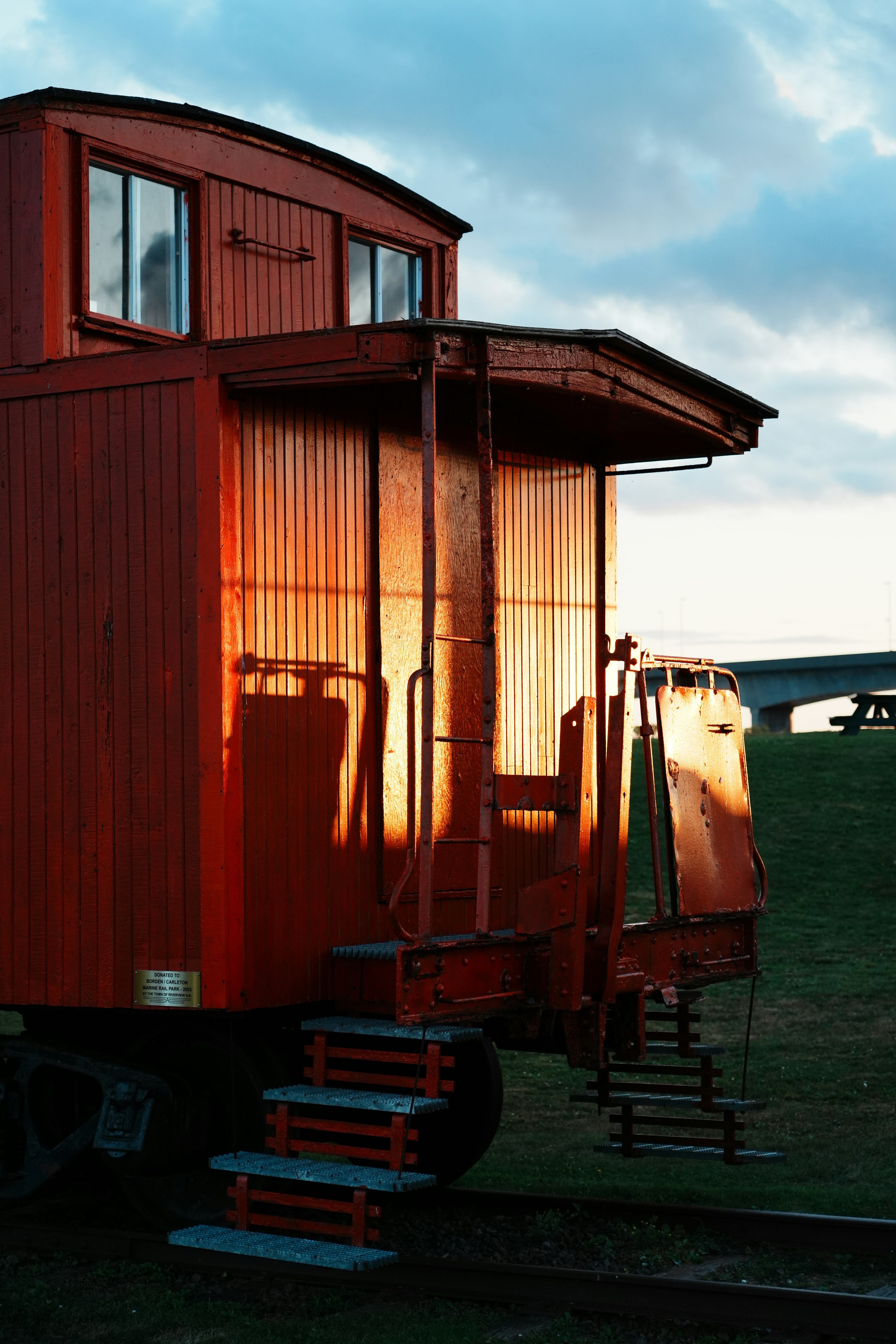 Red caboose bathed in warm sunset light