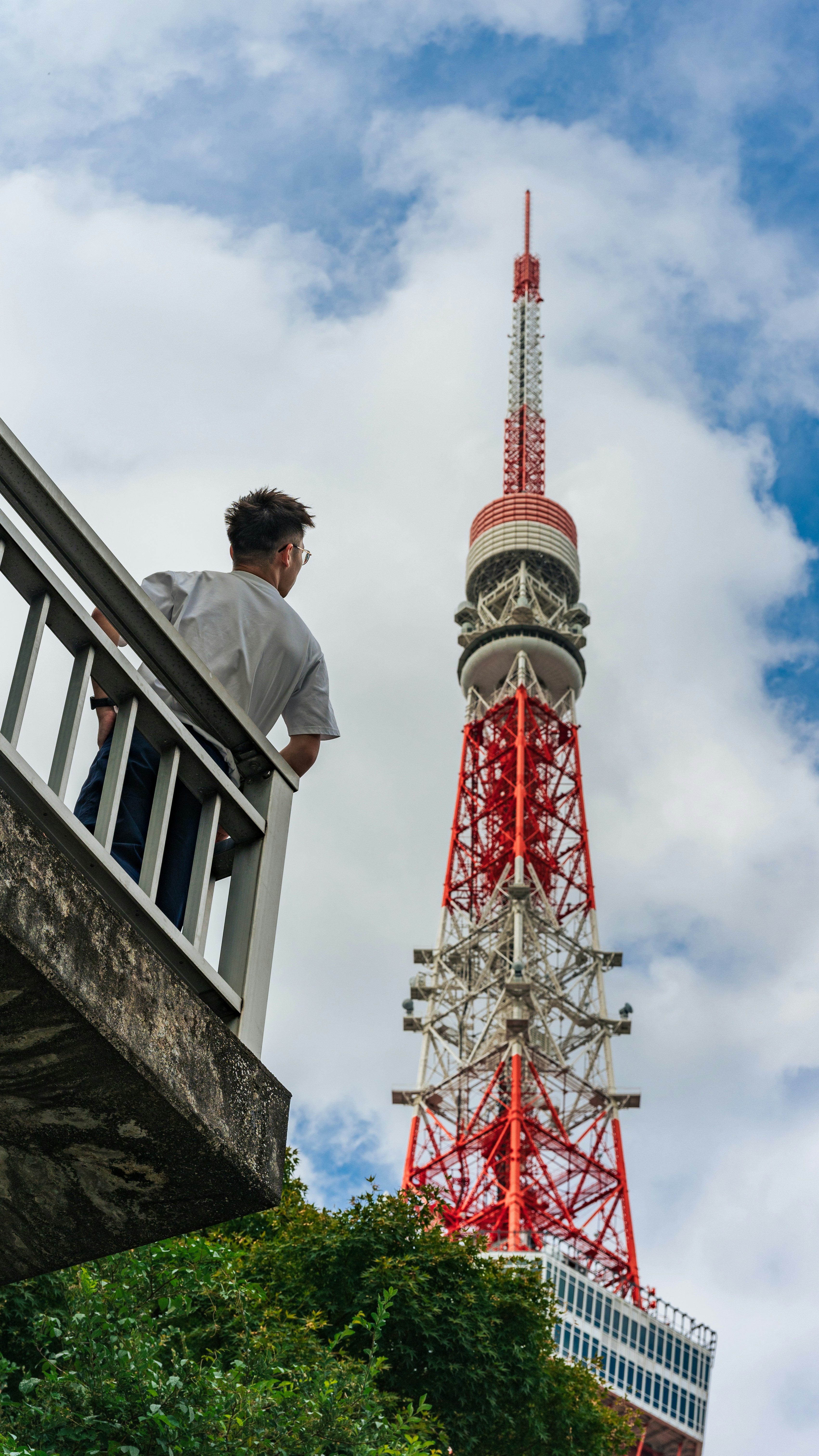 Balcony Perspective: Tokyo Tower Looms Over a Sky-Blue Skyline
