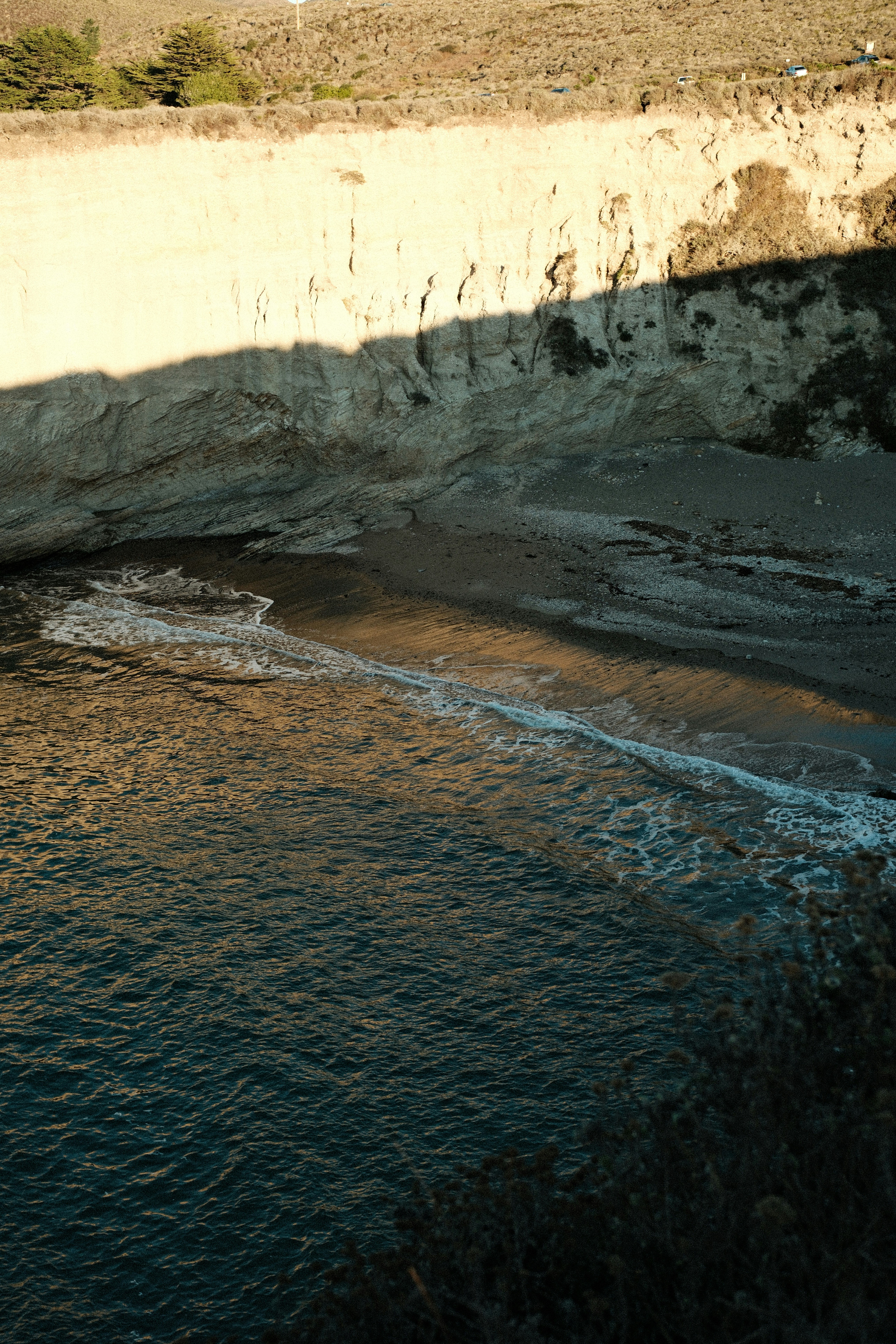 Golden Edge: Cliff Face Over a Quiet Tide