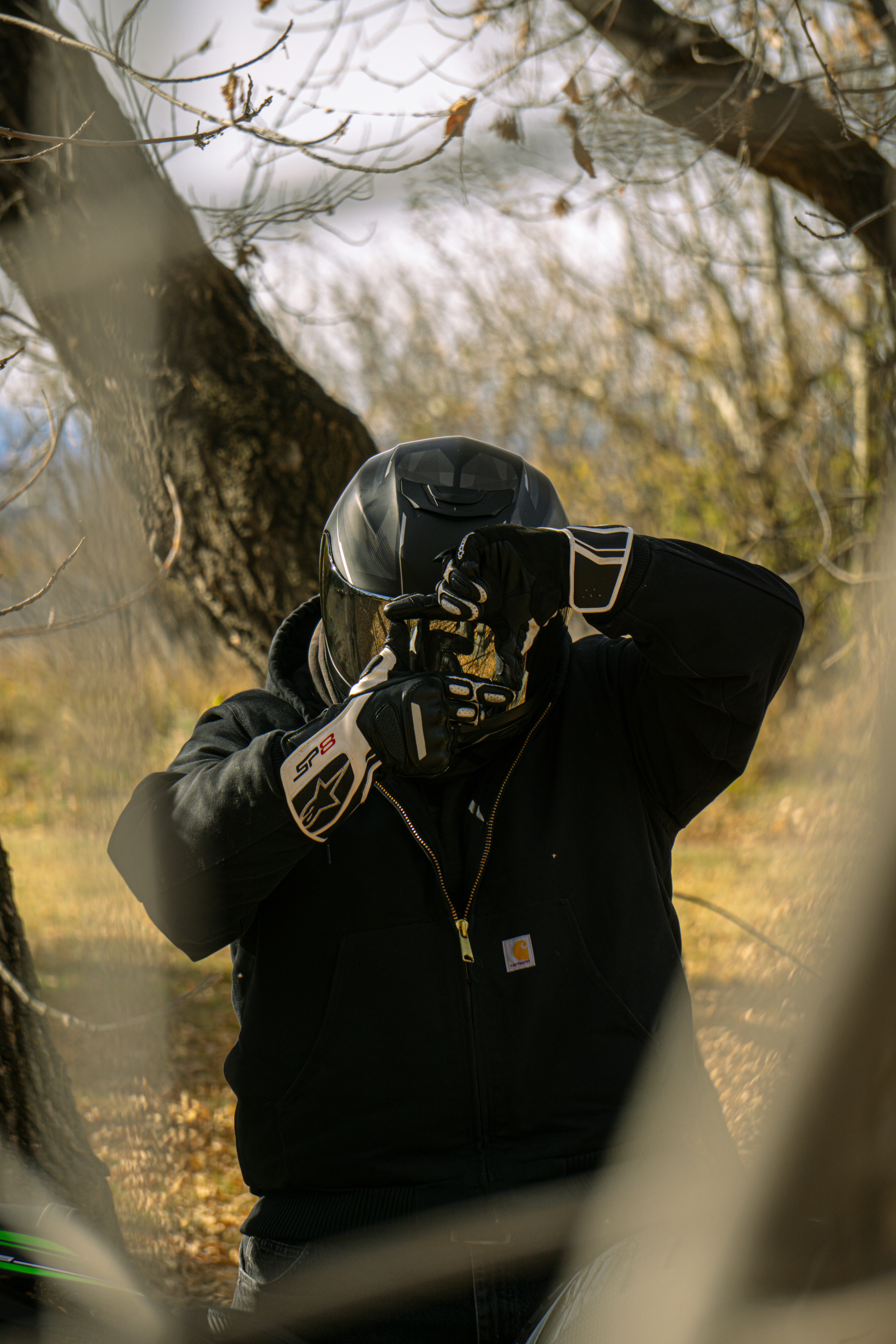 Helmeted Echoes: A Self-Portrait Through Autumn Branches