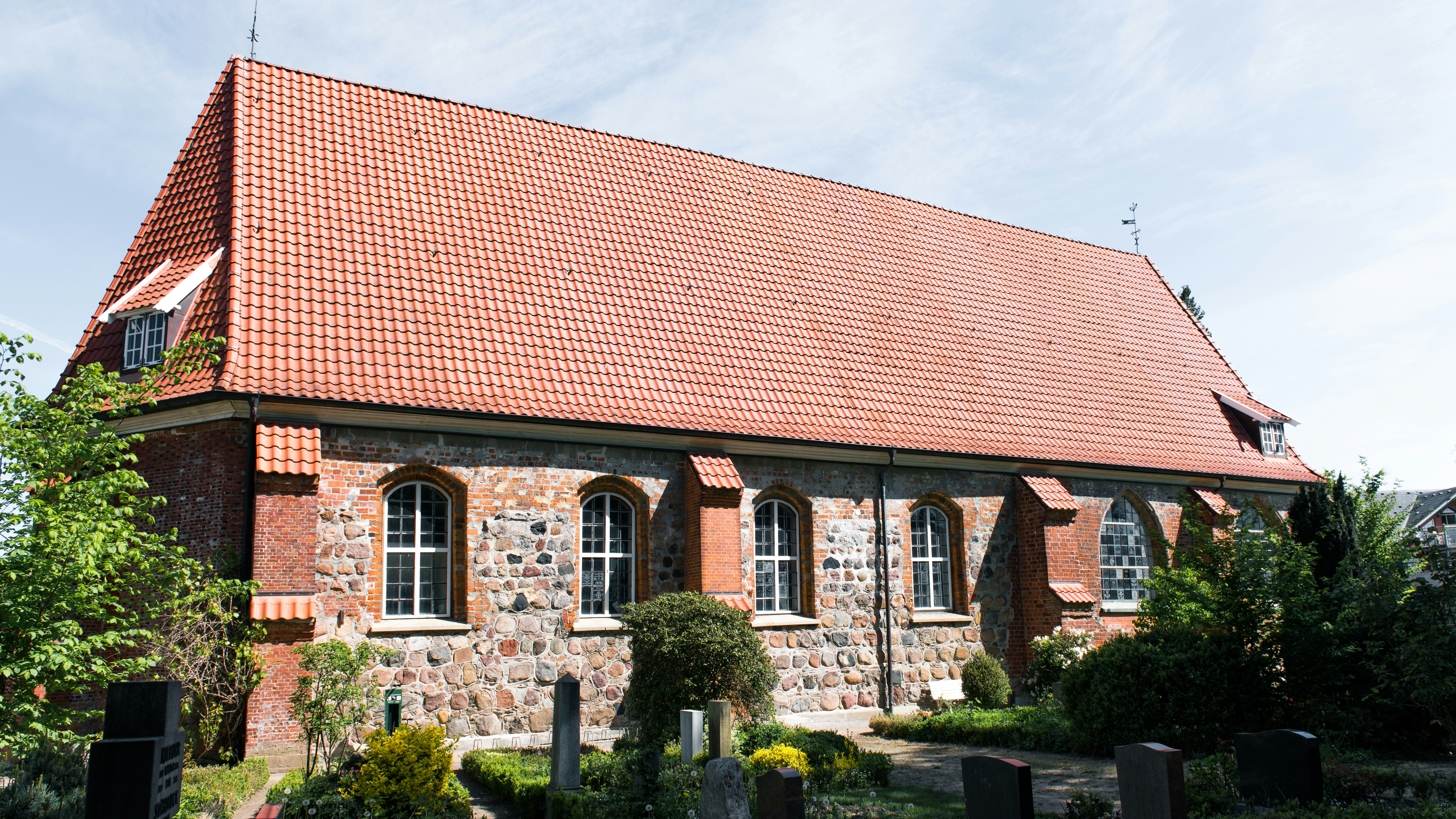 A historic church with a red tiled roof.