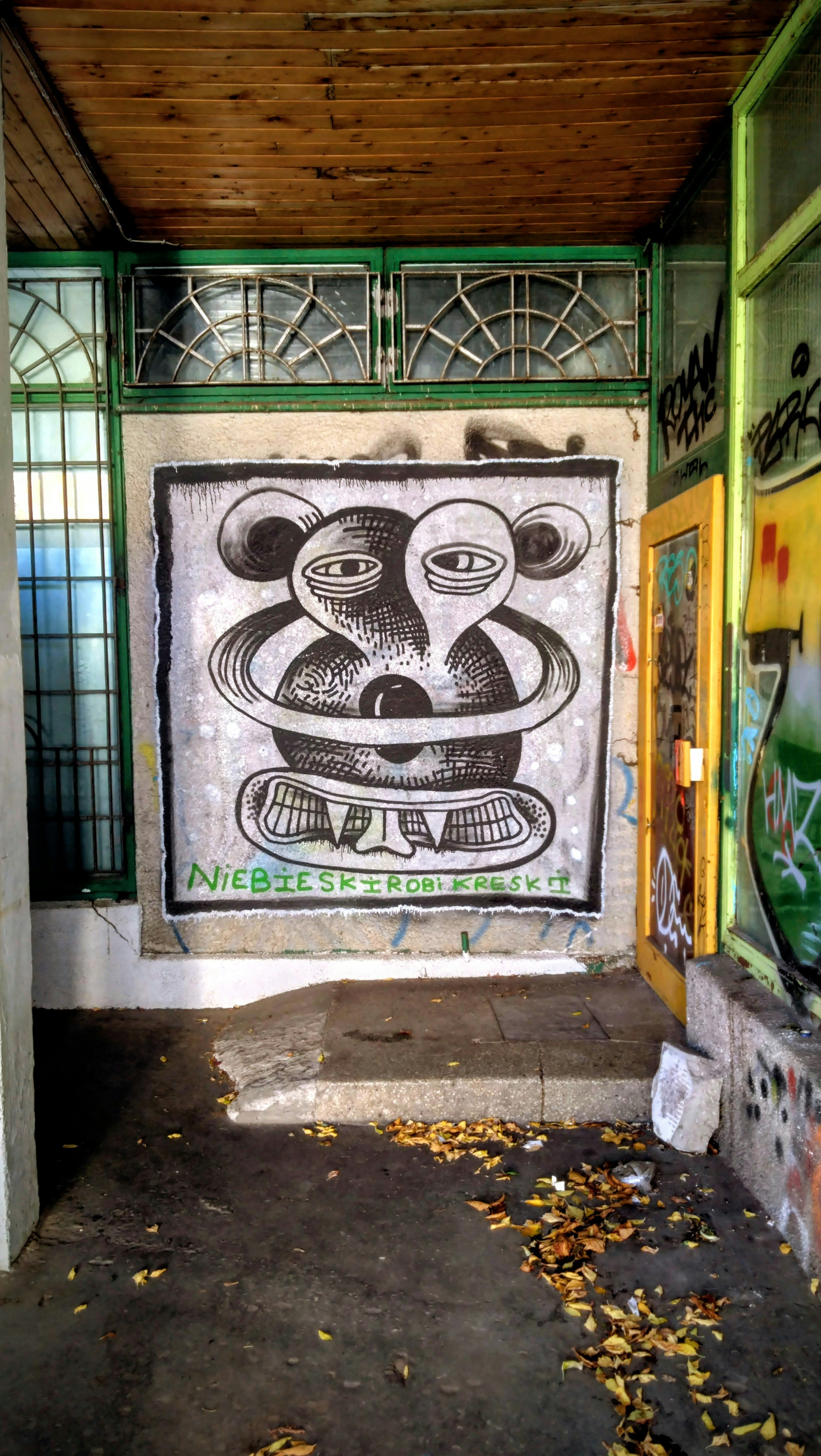 Graffiti art of a cartoonish face on a wall.