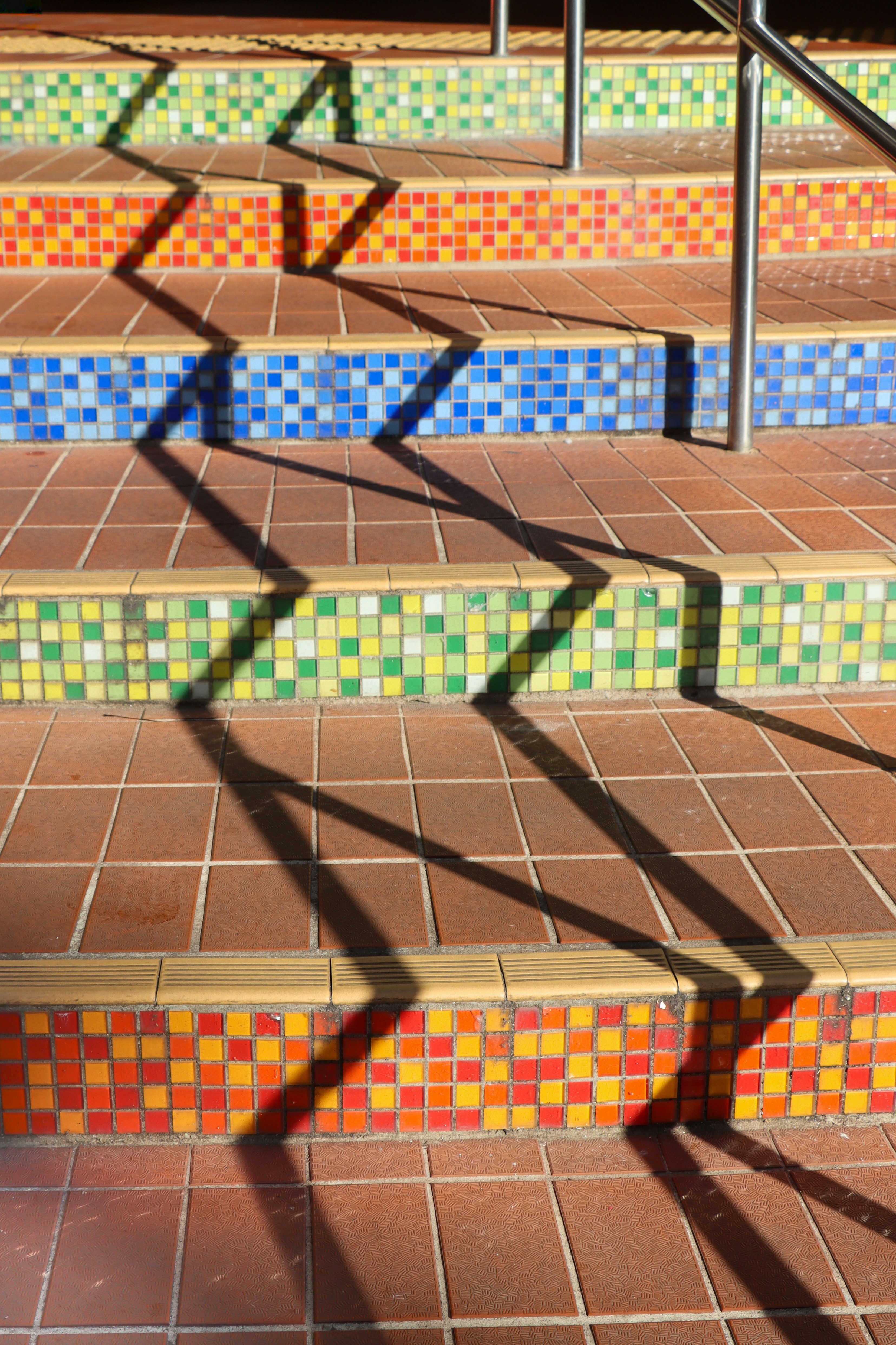 Rainbow Staircase: A Mosaic of Color and Zigzag Shadows