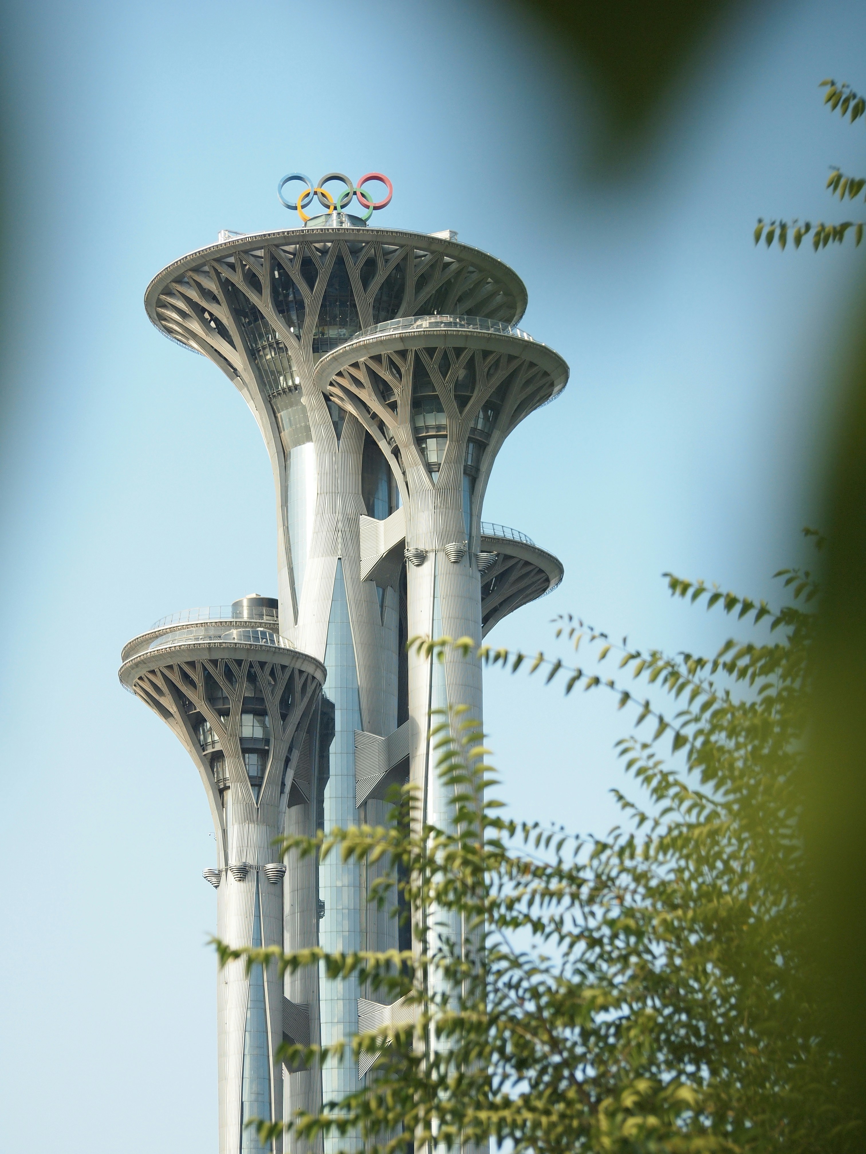 Rings on the Summit: Futuristic Towers Crowned by Olympic Emblems