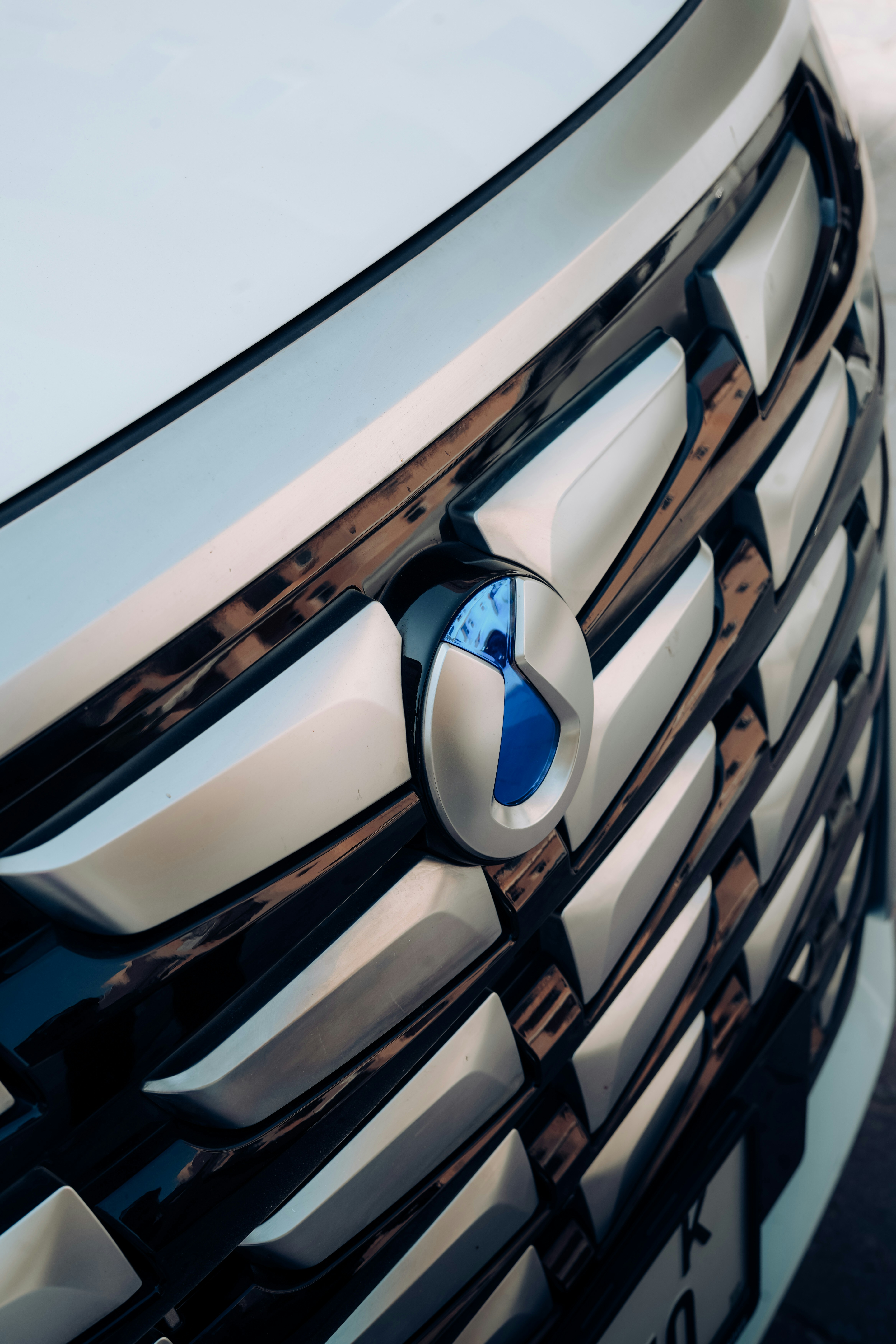 Chrome Lattice, Blue Emblem: A Tight Portrait of a Modern Front Grille