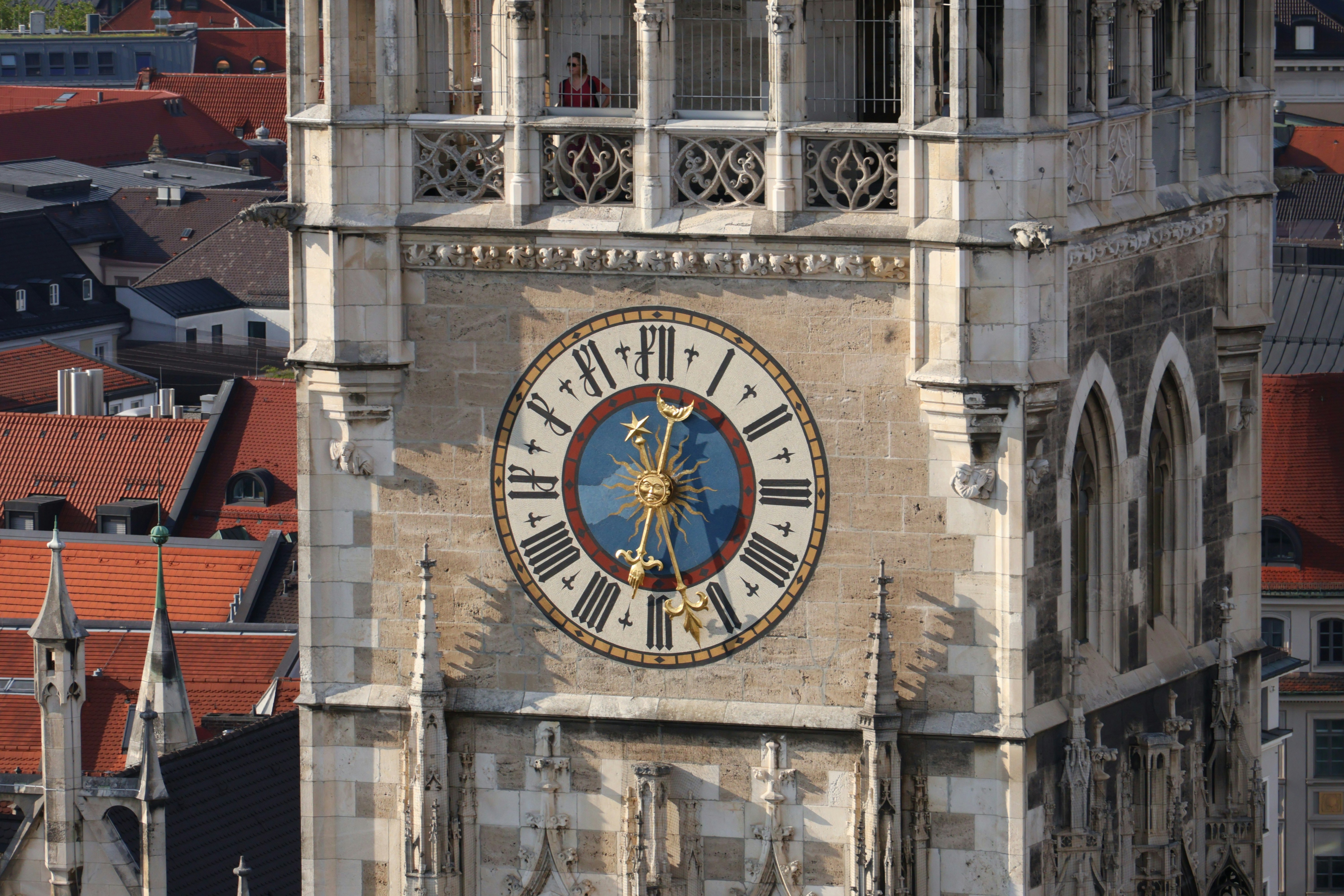Azure Dial Above Stone Spires: Timekeeping Amid Red Roofs