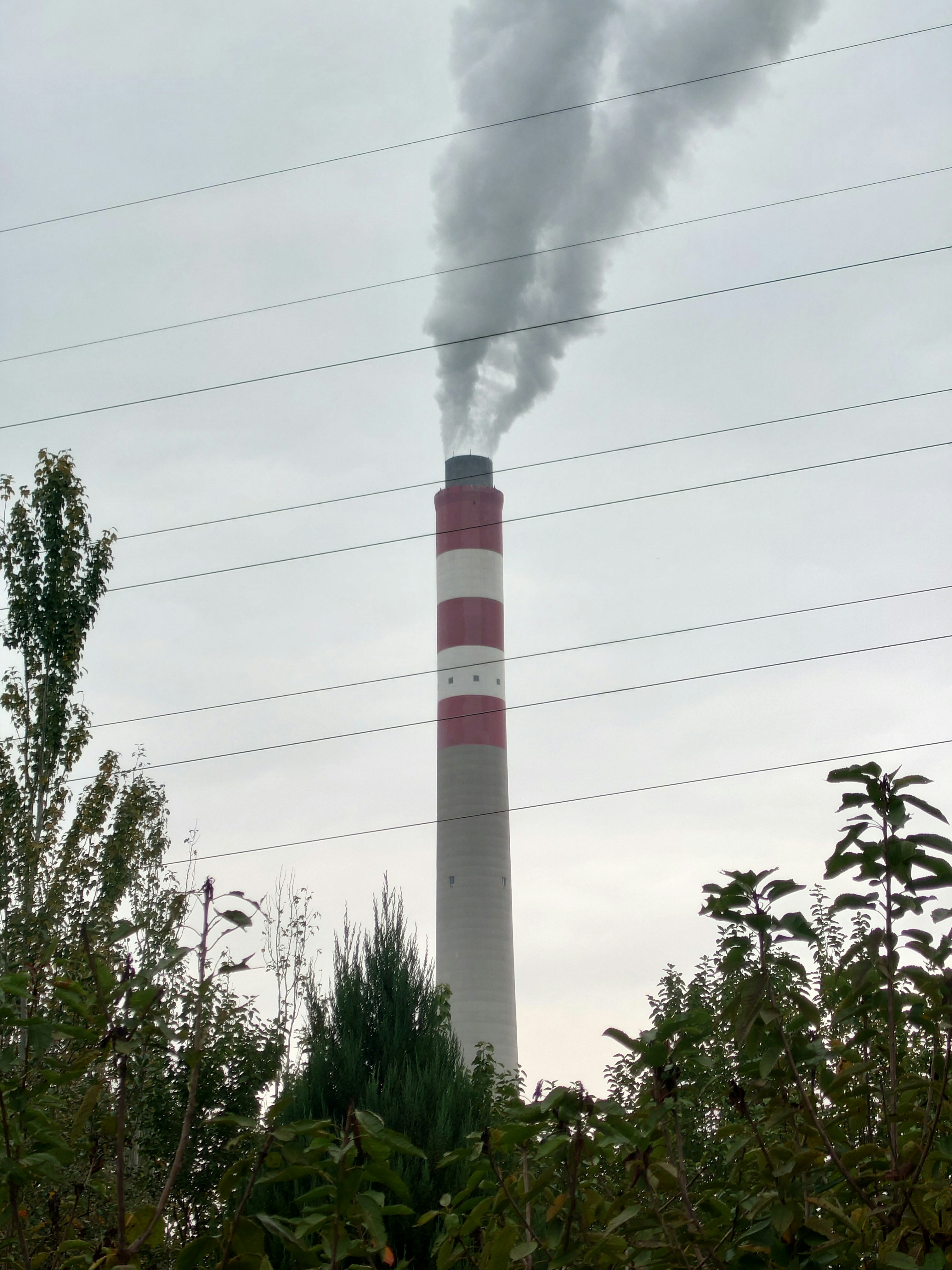 Tall smokestack emitting smoke into the sky