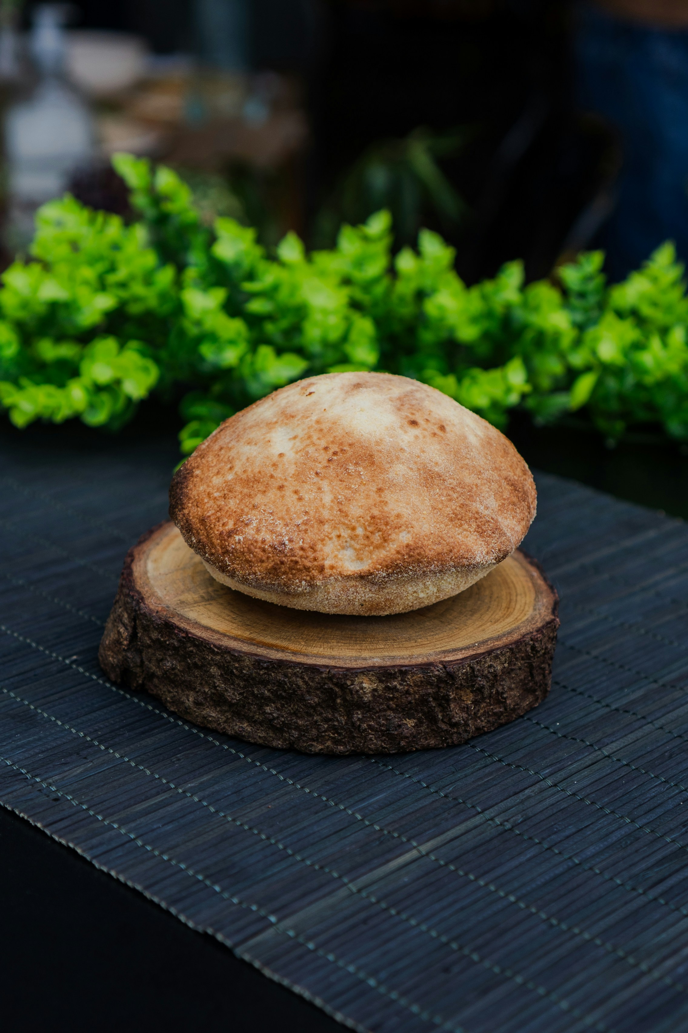 A round pita bread on a wooden stand