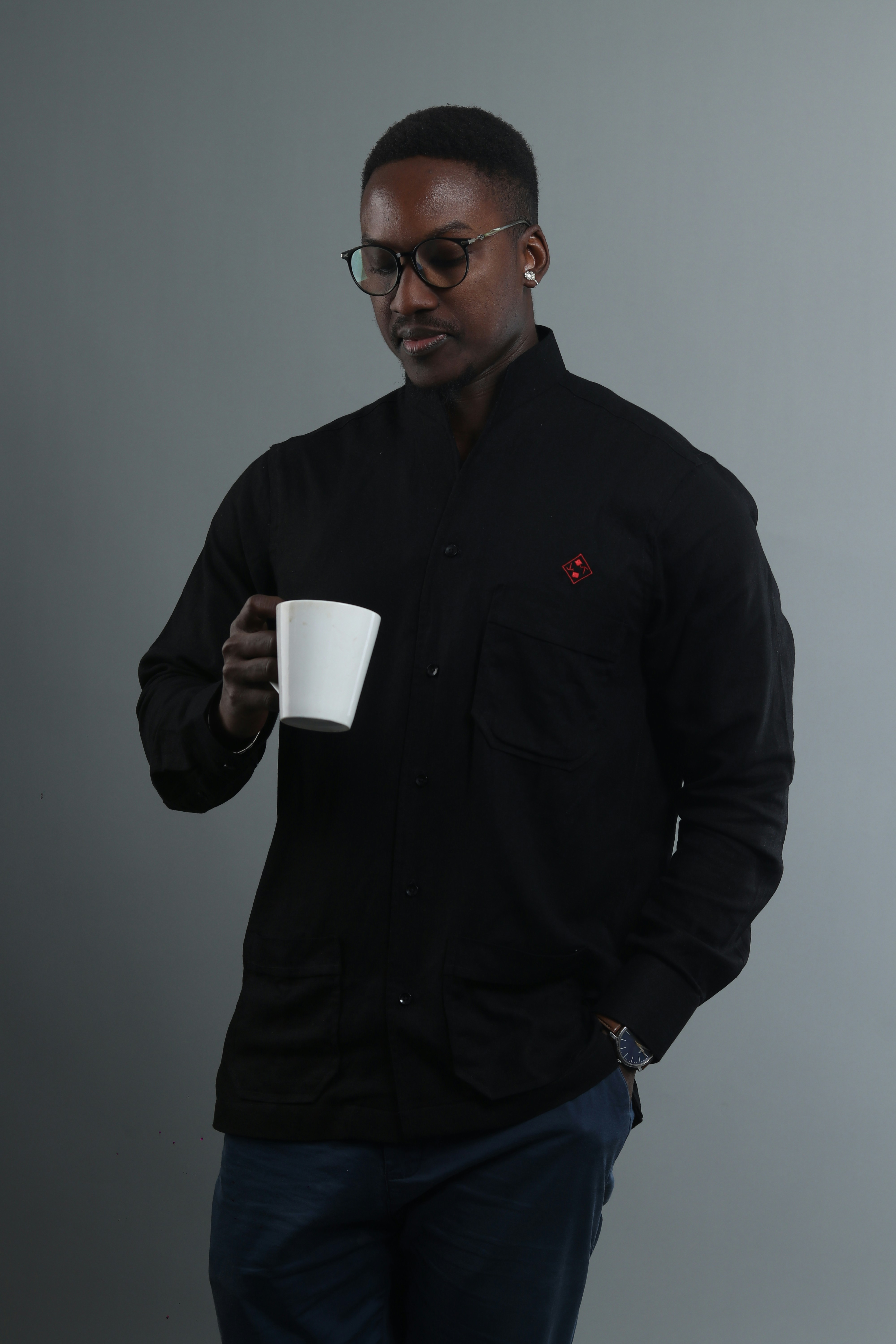 ethniebrand.com | A man in a black shirt holding a white mug.