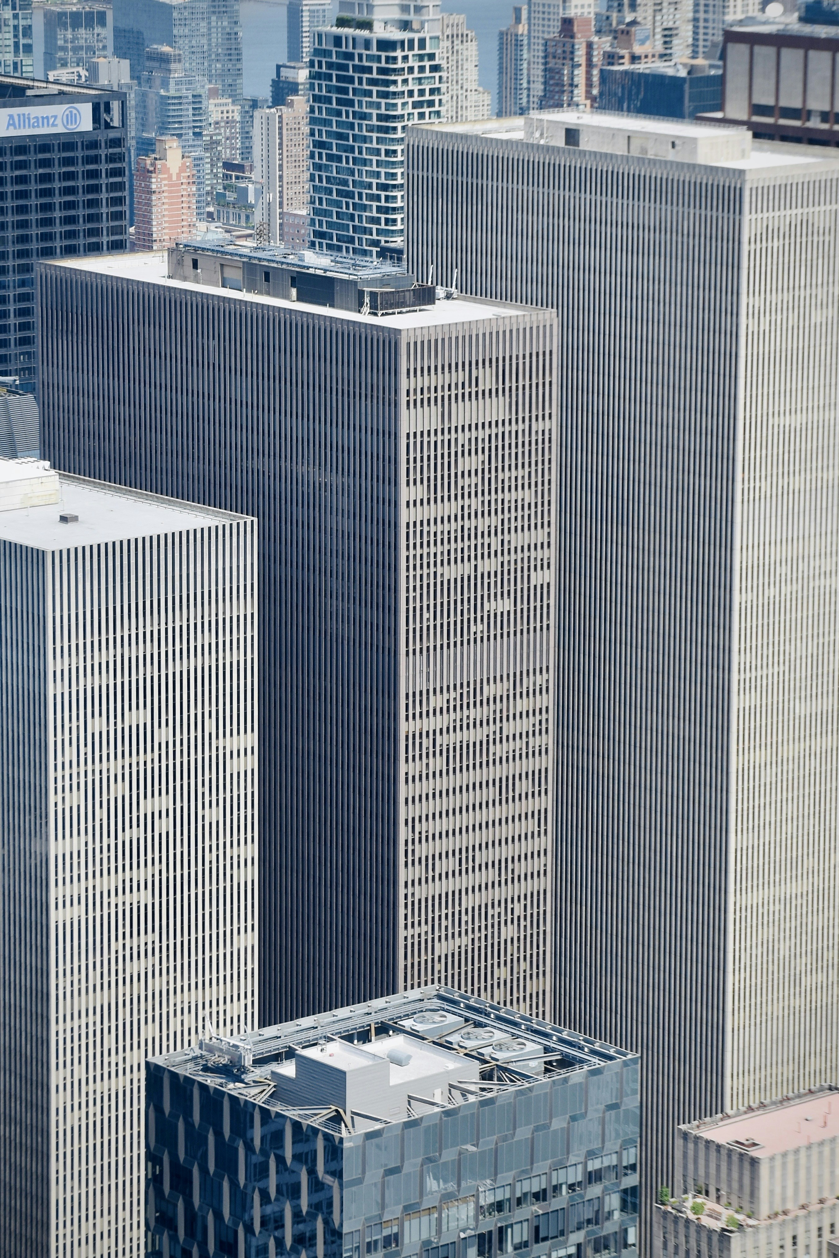 Close-up view of modern skyscrapers showcasing intricate architectural lines and textures. The image highlights the interplay of light and shadow on the building facades.