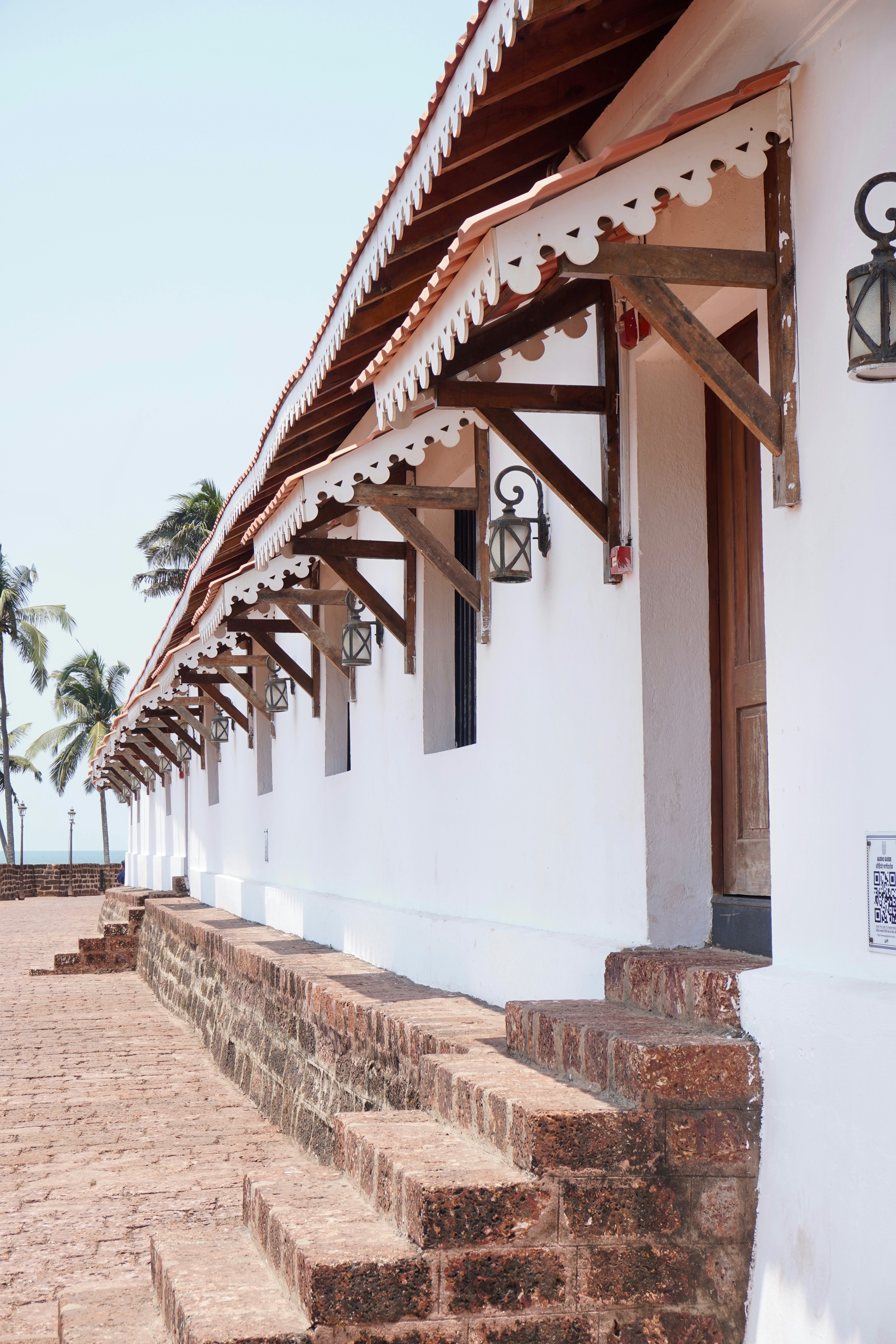Lantern-Lined Veranda: Sunlit Steps by the Sea