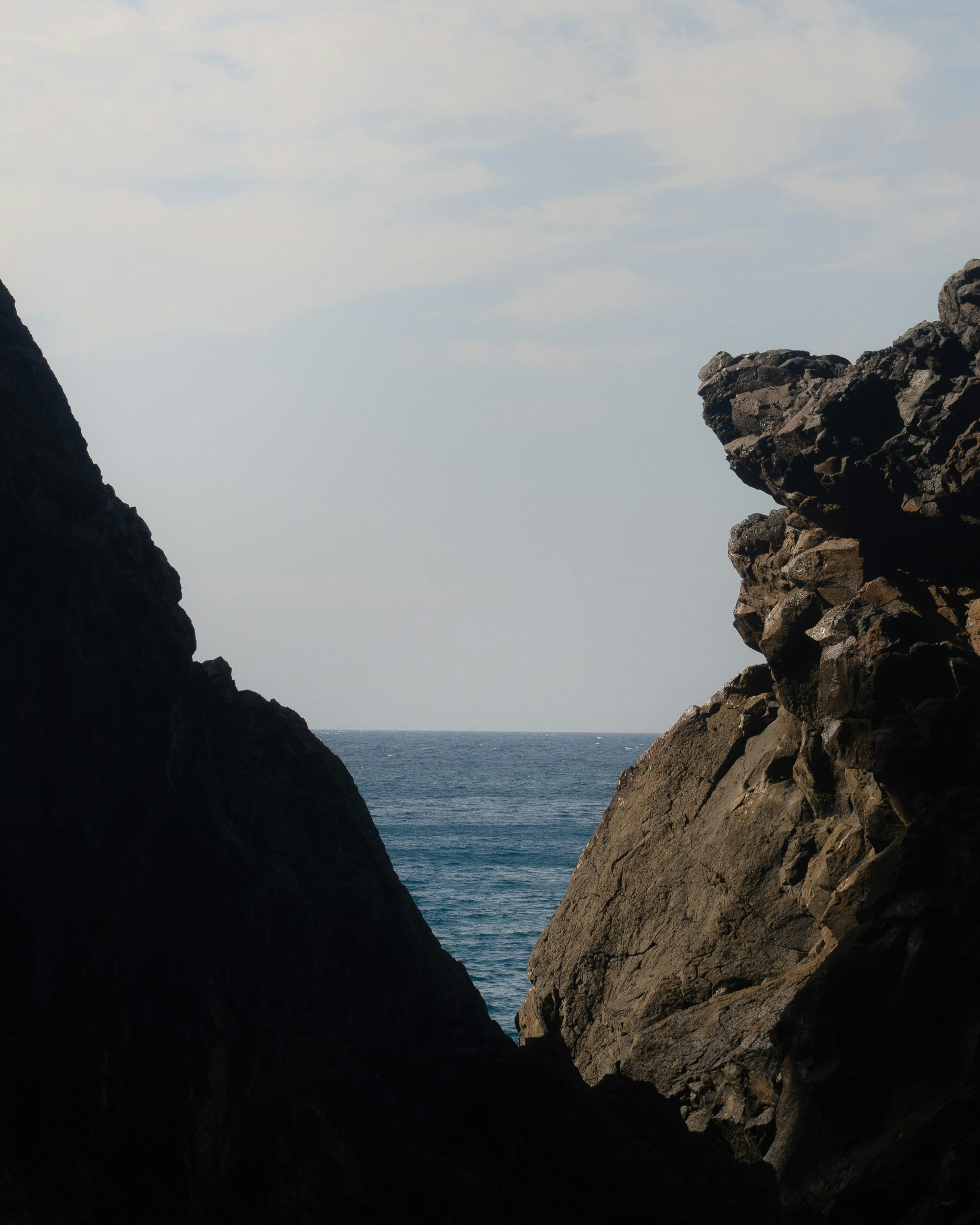 A little pocket of wild ocean. | Ocean view between two rocky cliffs