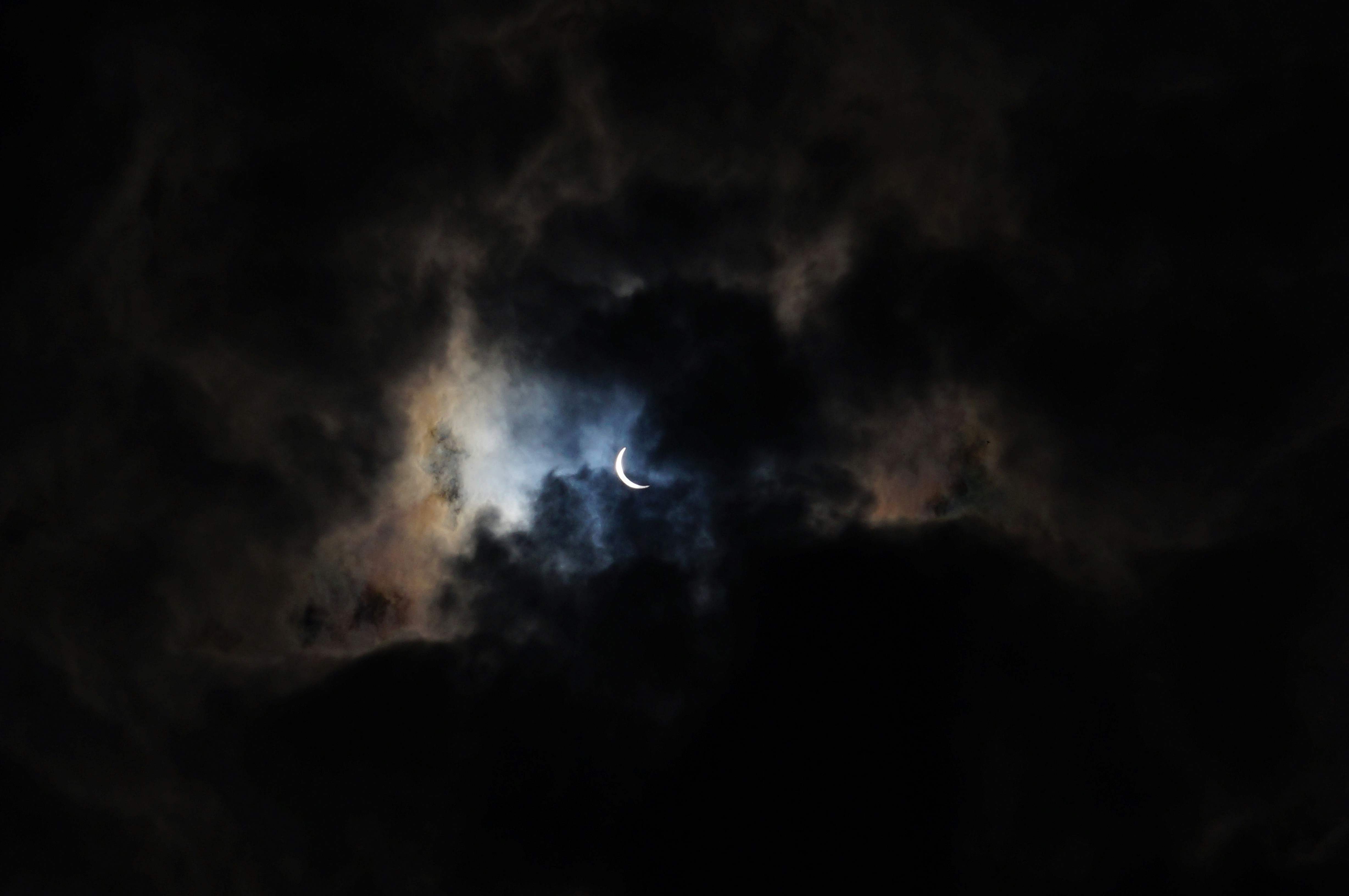 Solar eclipse | Partial solar eclipse seen through dark clouds