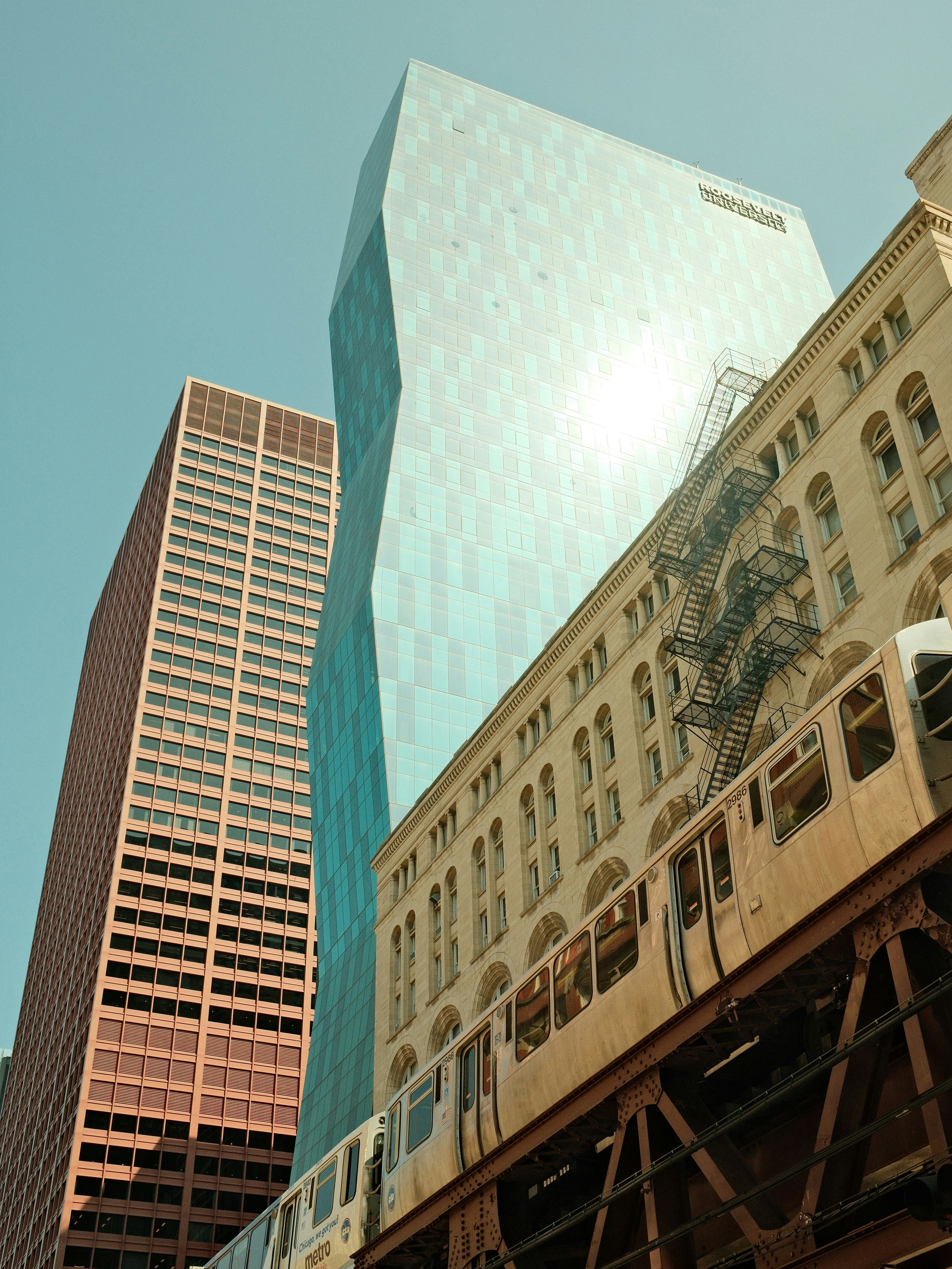 Skyscraper Symmetry: Glass Tower and Elevated Transit in a Sunlit City