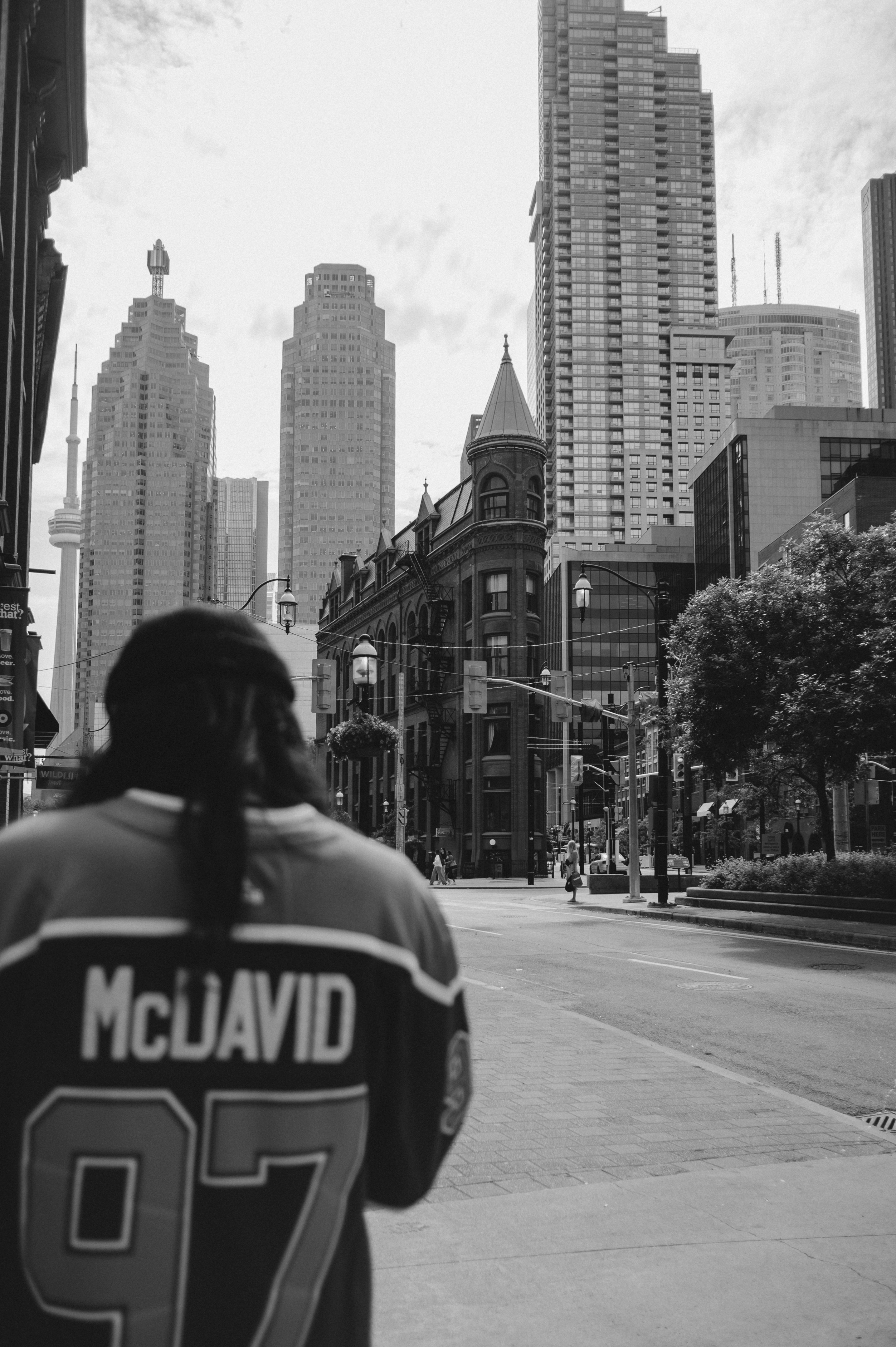Person in mcdavid jersey facing city skyline